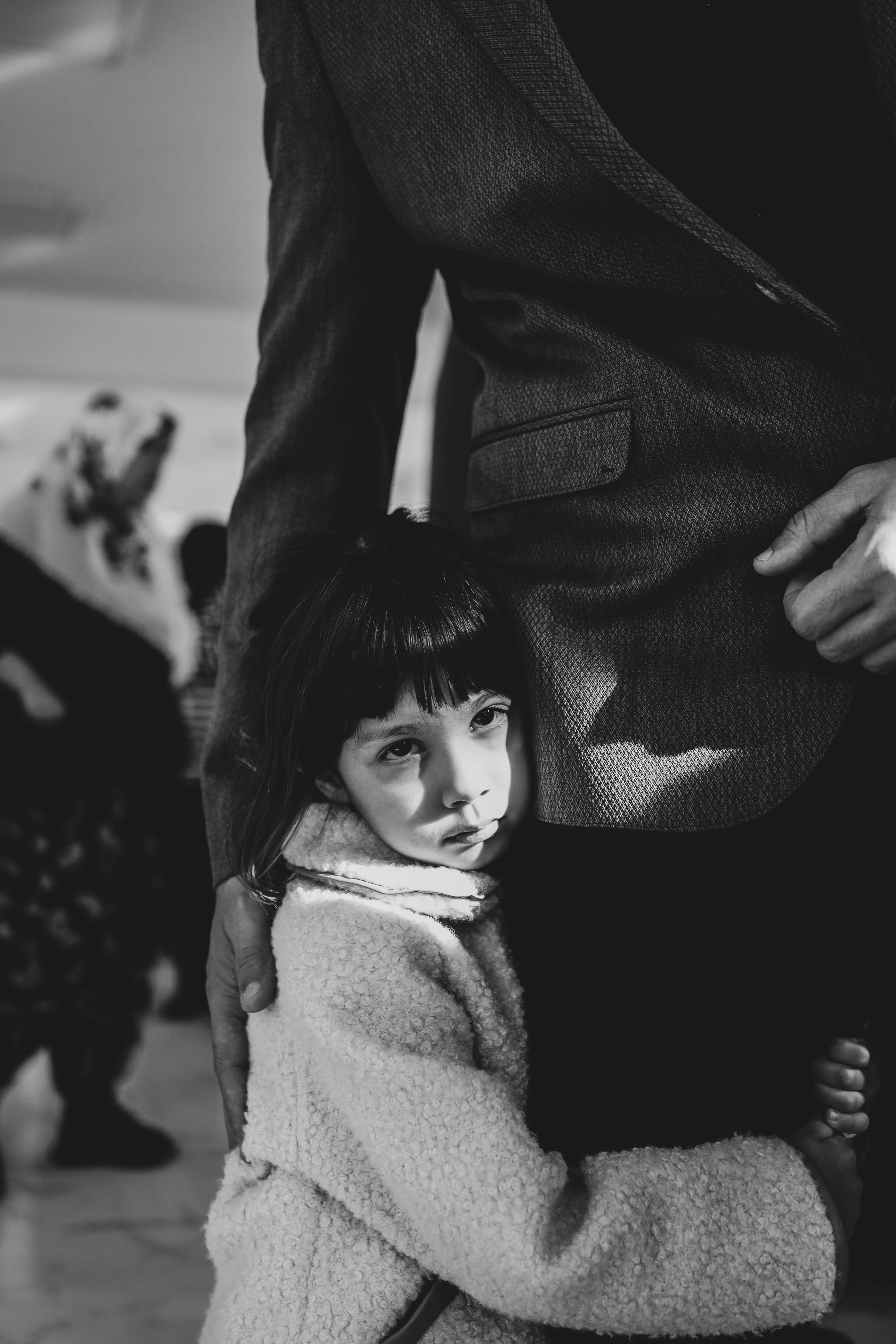 Child Embraces Adult in Protective Hug · Free Stock Photo