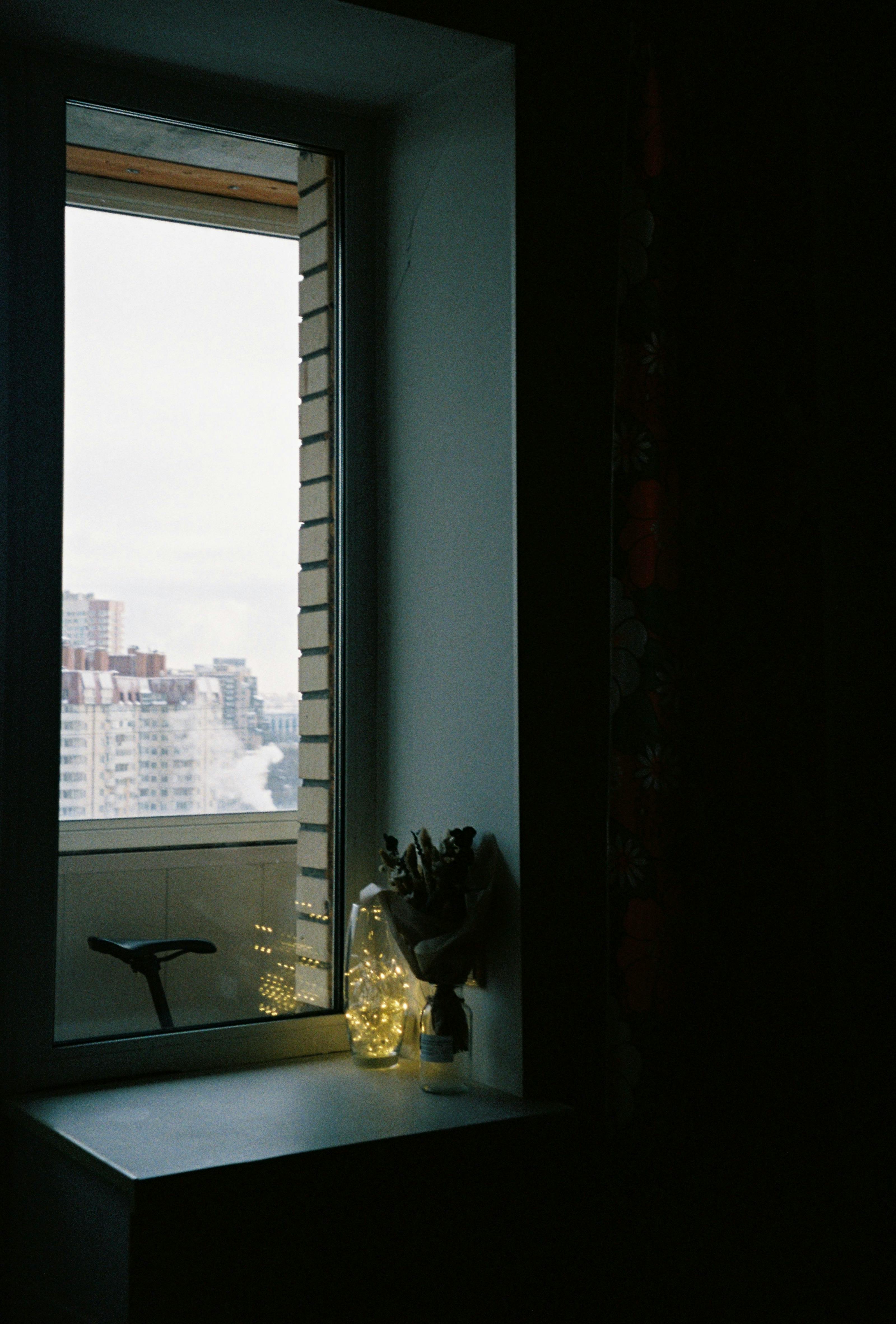 Cozy Window View with Cityscape and Fairy Lights · Free Stock Photo