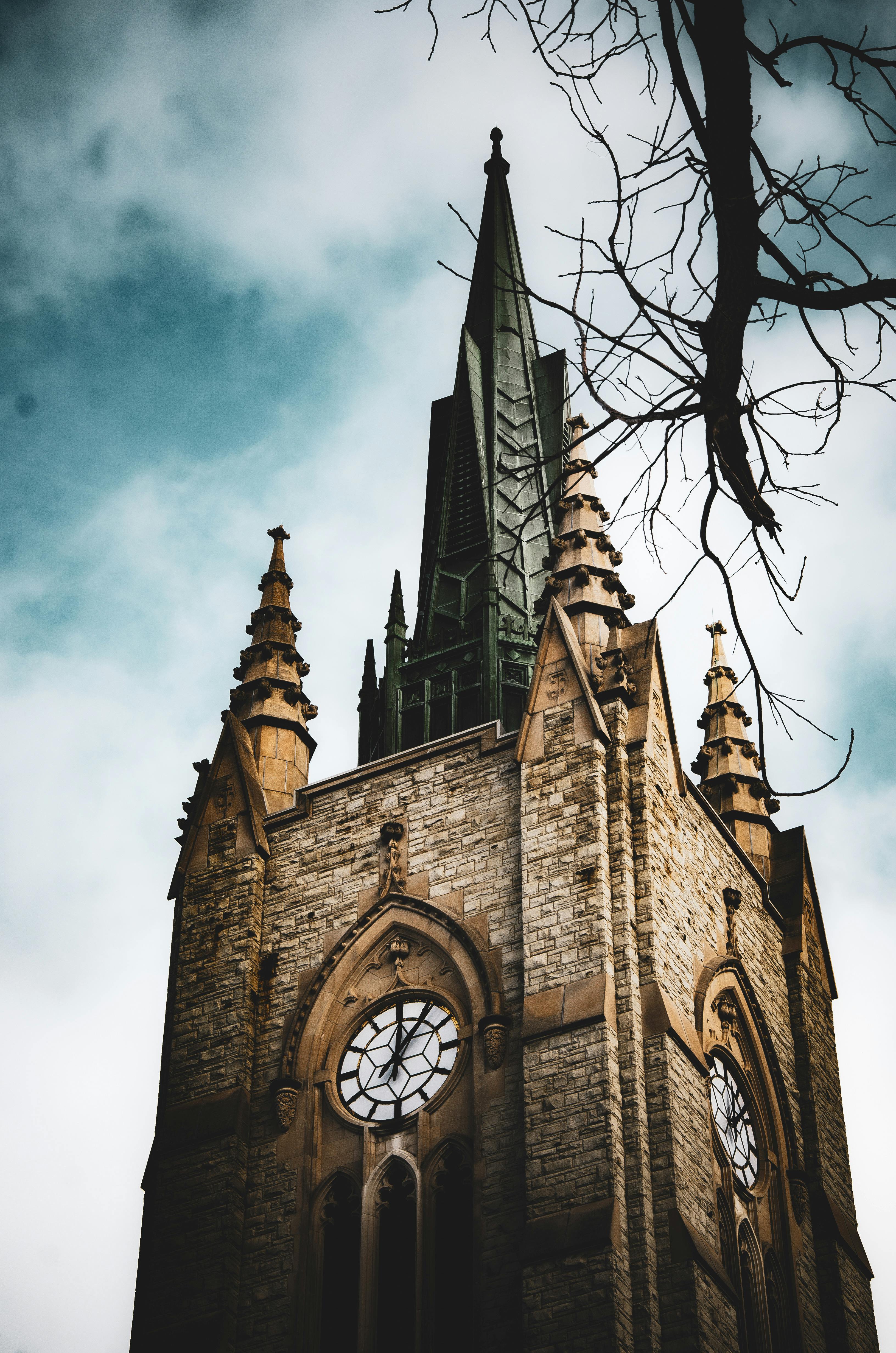 Gothic Church Tower Against Moody Sky · Free Stock Photo