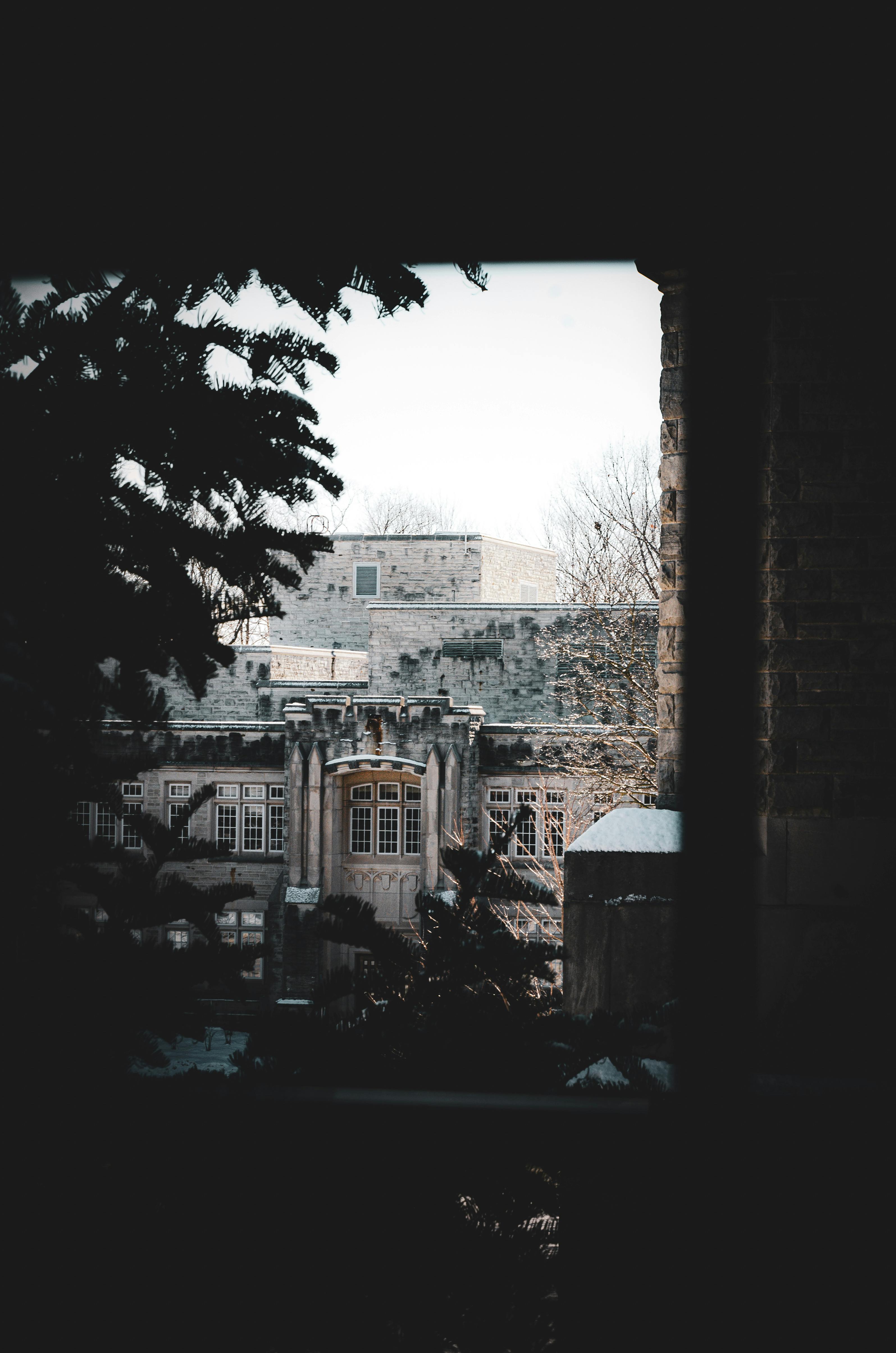 Snowy Gothic Architecture Viewed Through Window · Free Stock Photo