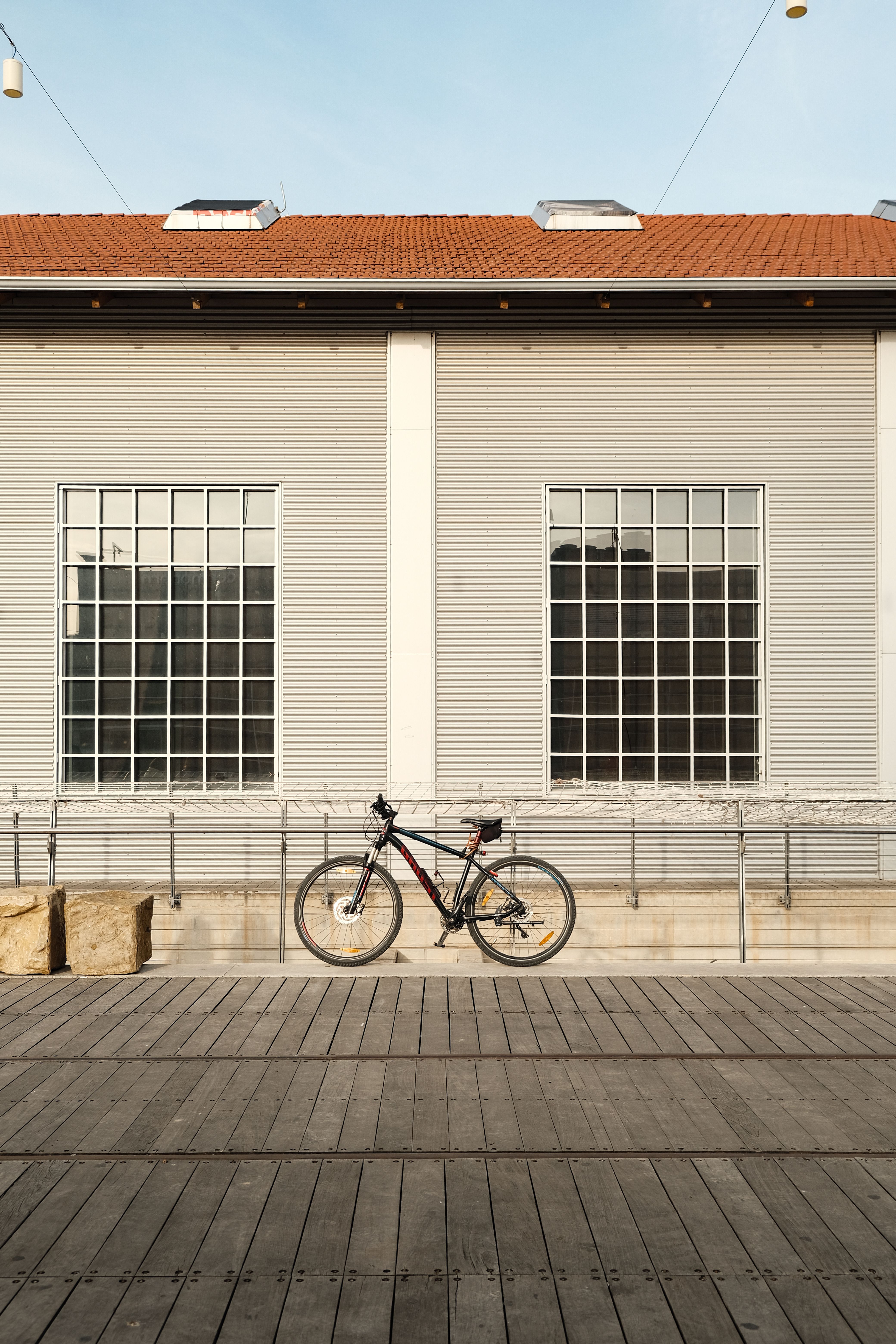 Bicycle Parked Against Industrial Building · Free Stock Photo