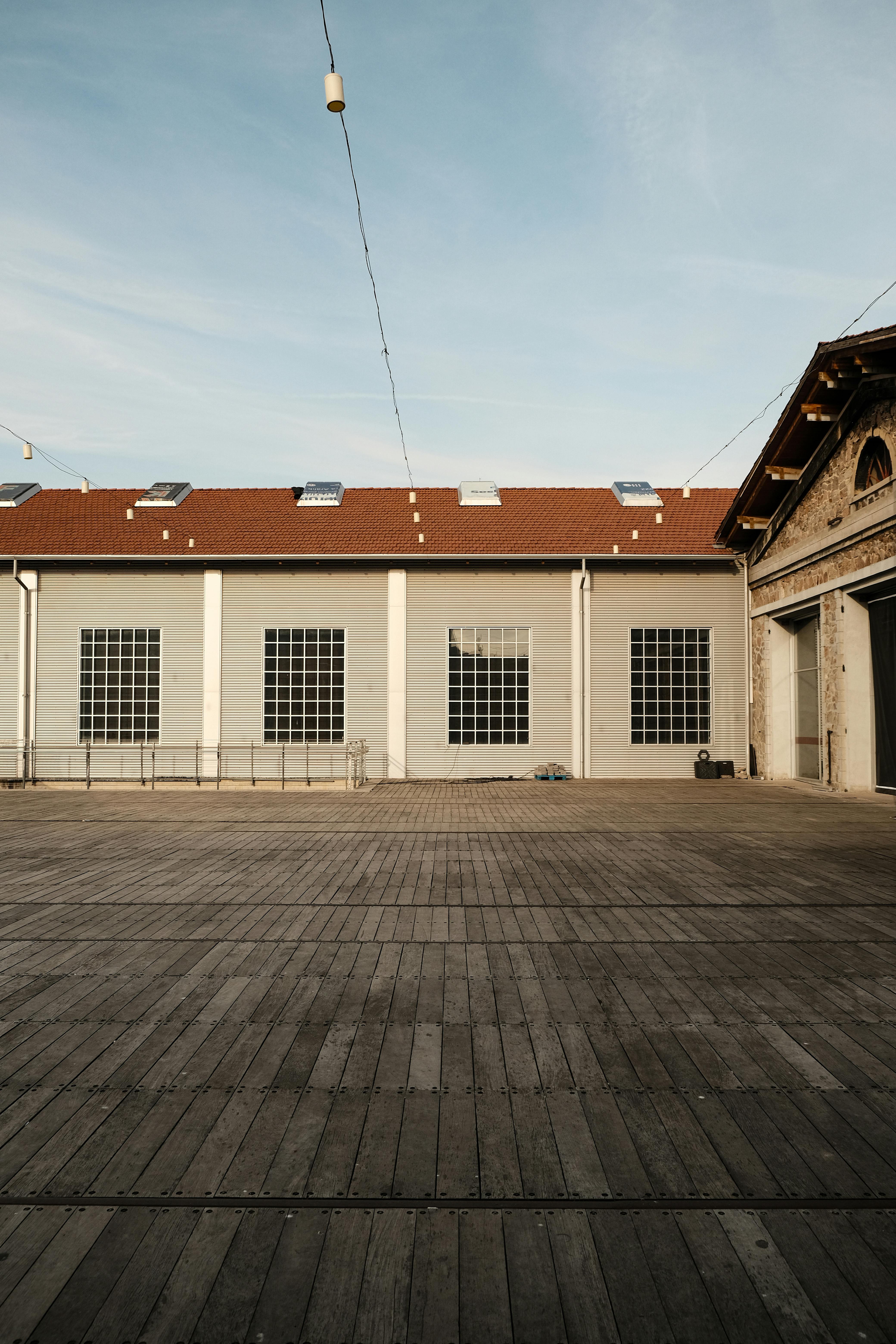 Industrial Building with Wooden Forecourt · Free Stock Photo