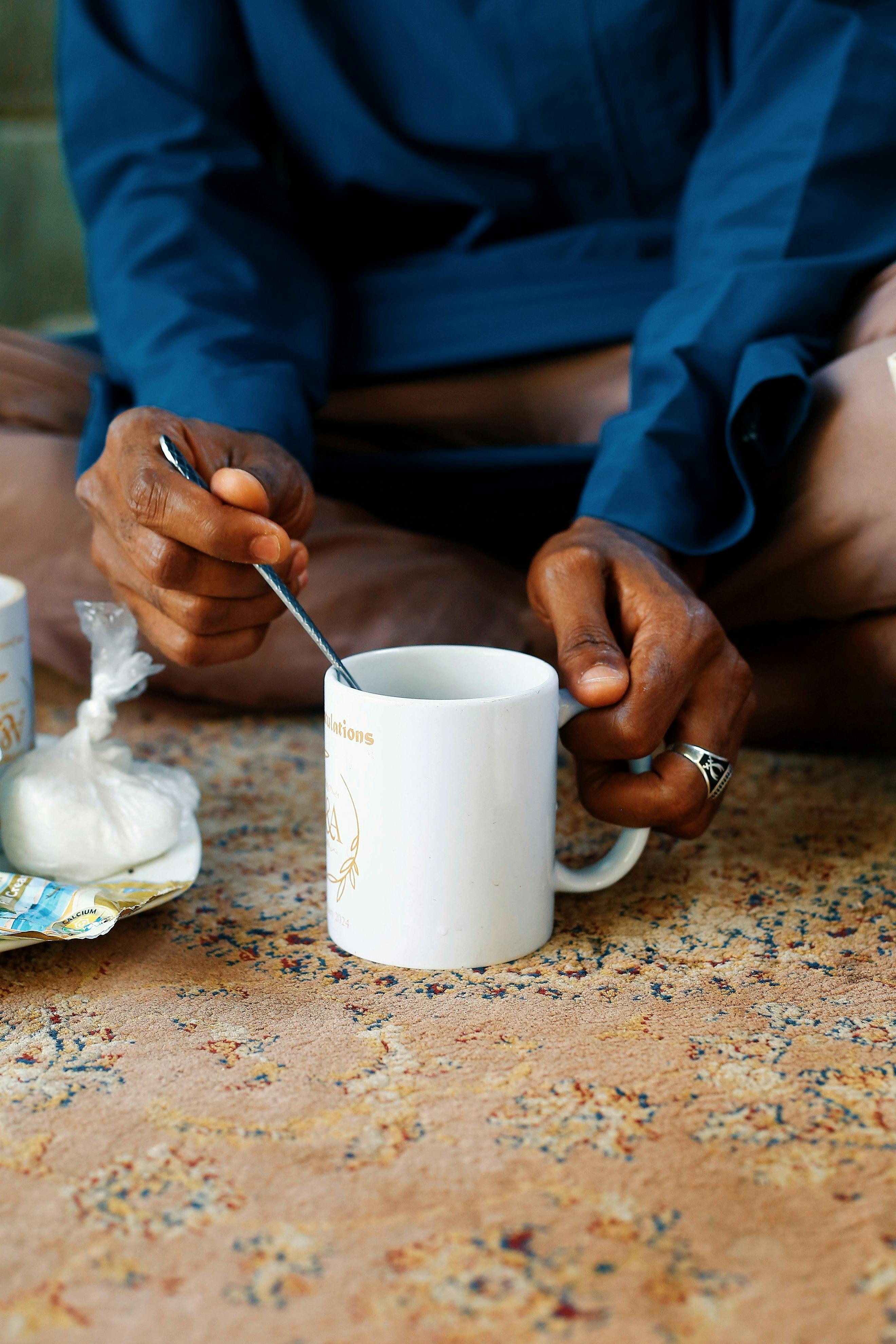 Person Stirring Tea in Abuja, Nigeria · Free Stock Photo