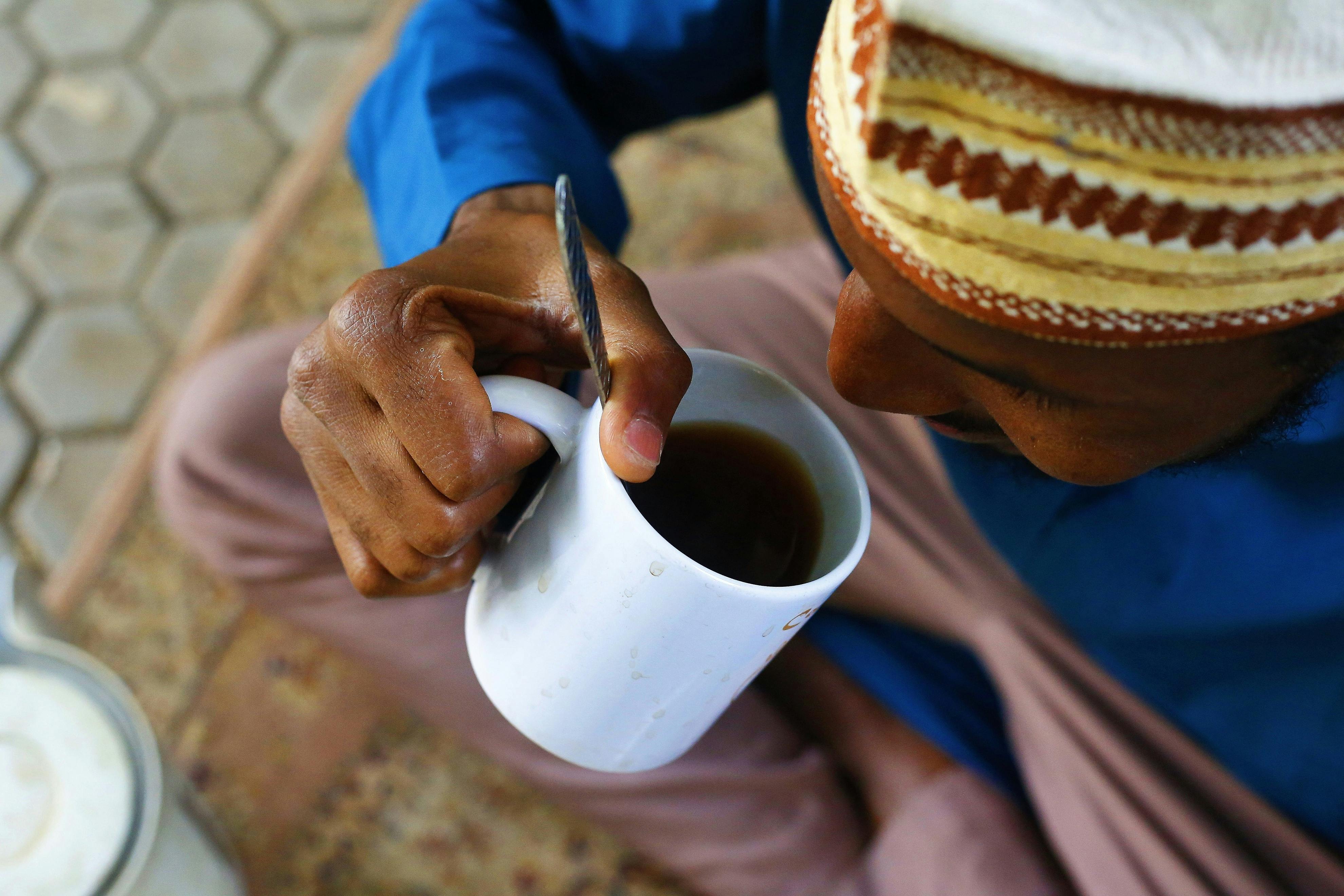 Man Enjoying Tea in Traditional Nigerian Setting · Free Stock Photo