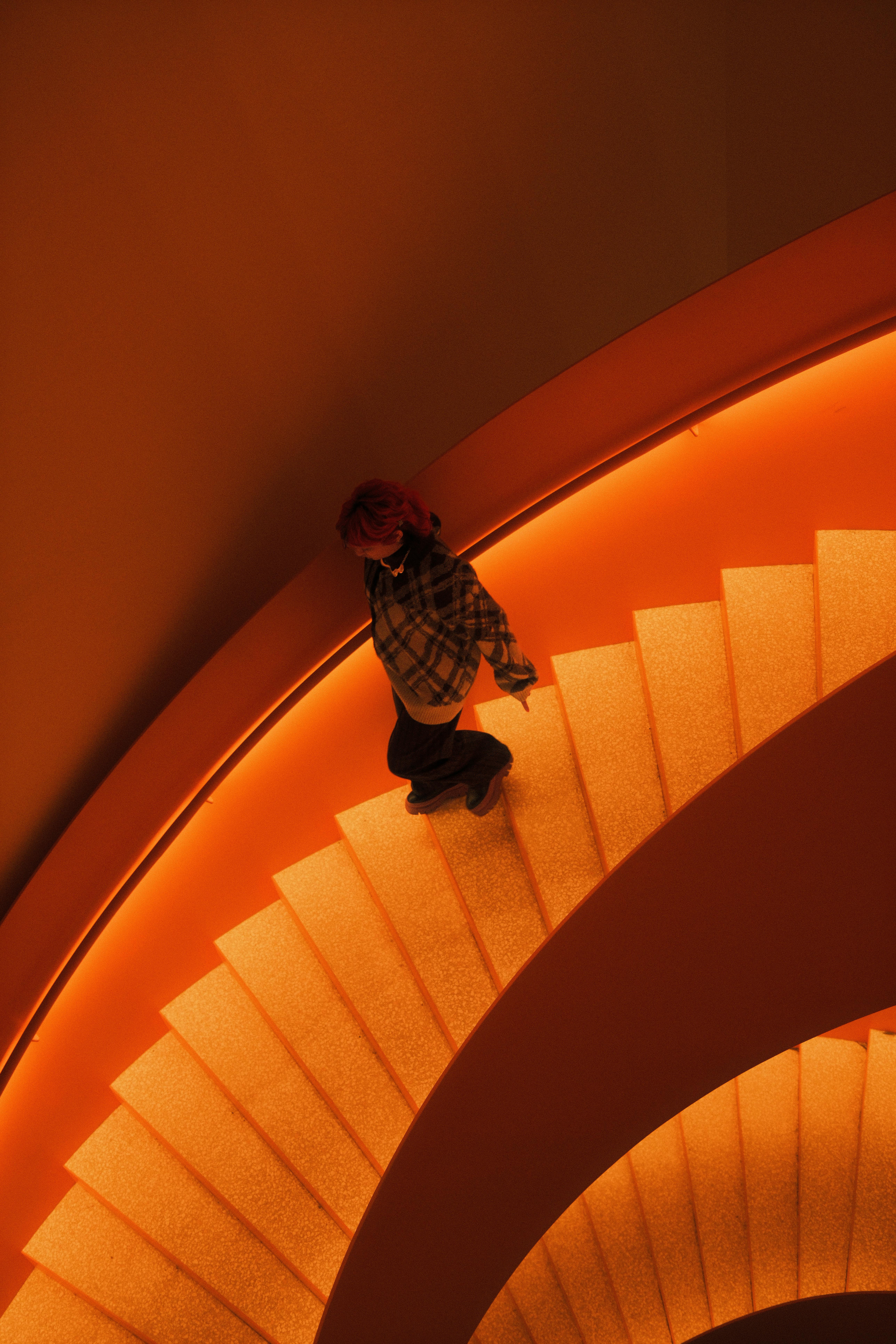 Artistic Spiral Staircase with Person Descending · Free Stock Photo