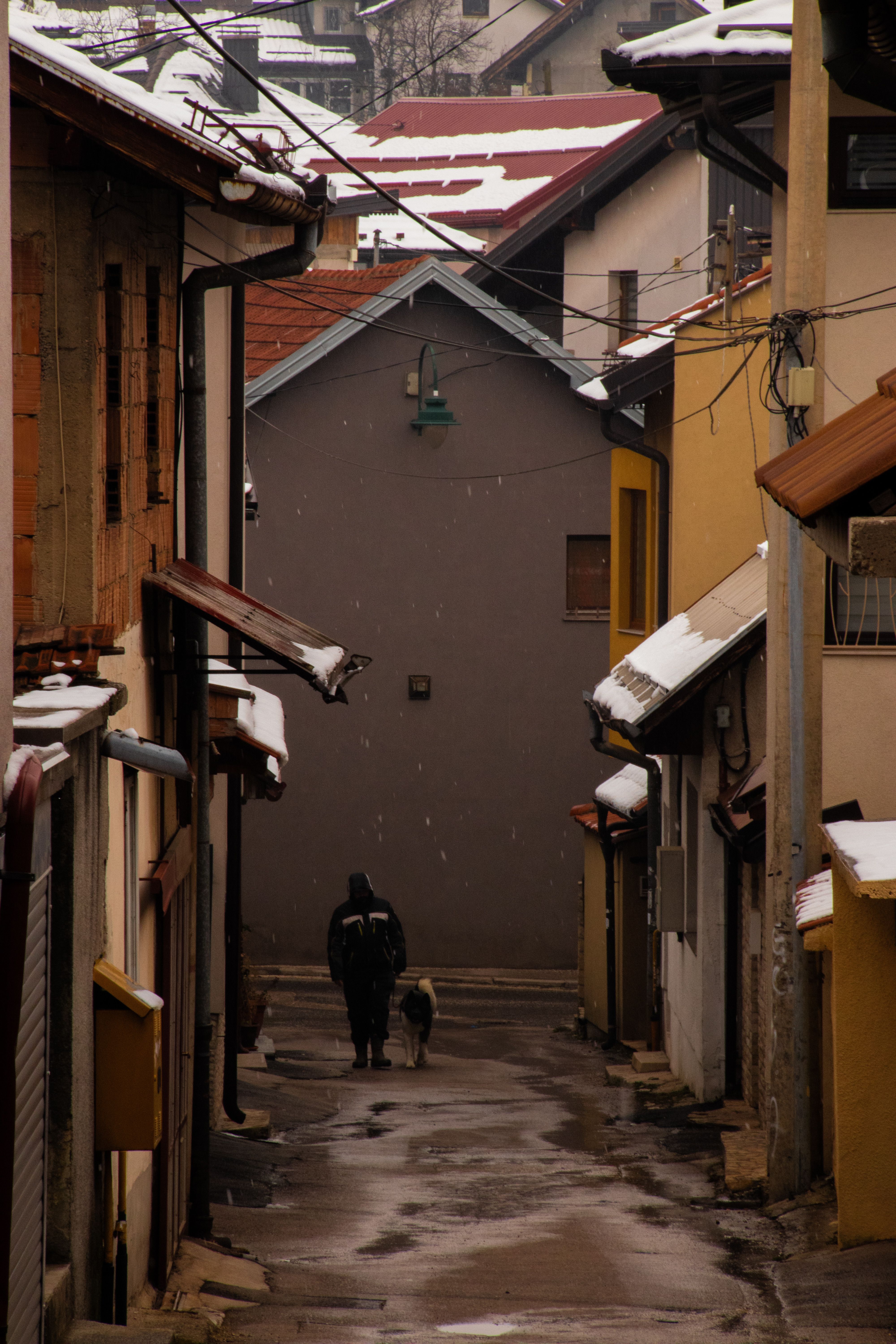 Narrow Snowy Alley in a Rustic Urban Setting · Free Stock Photo