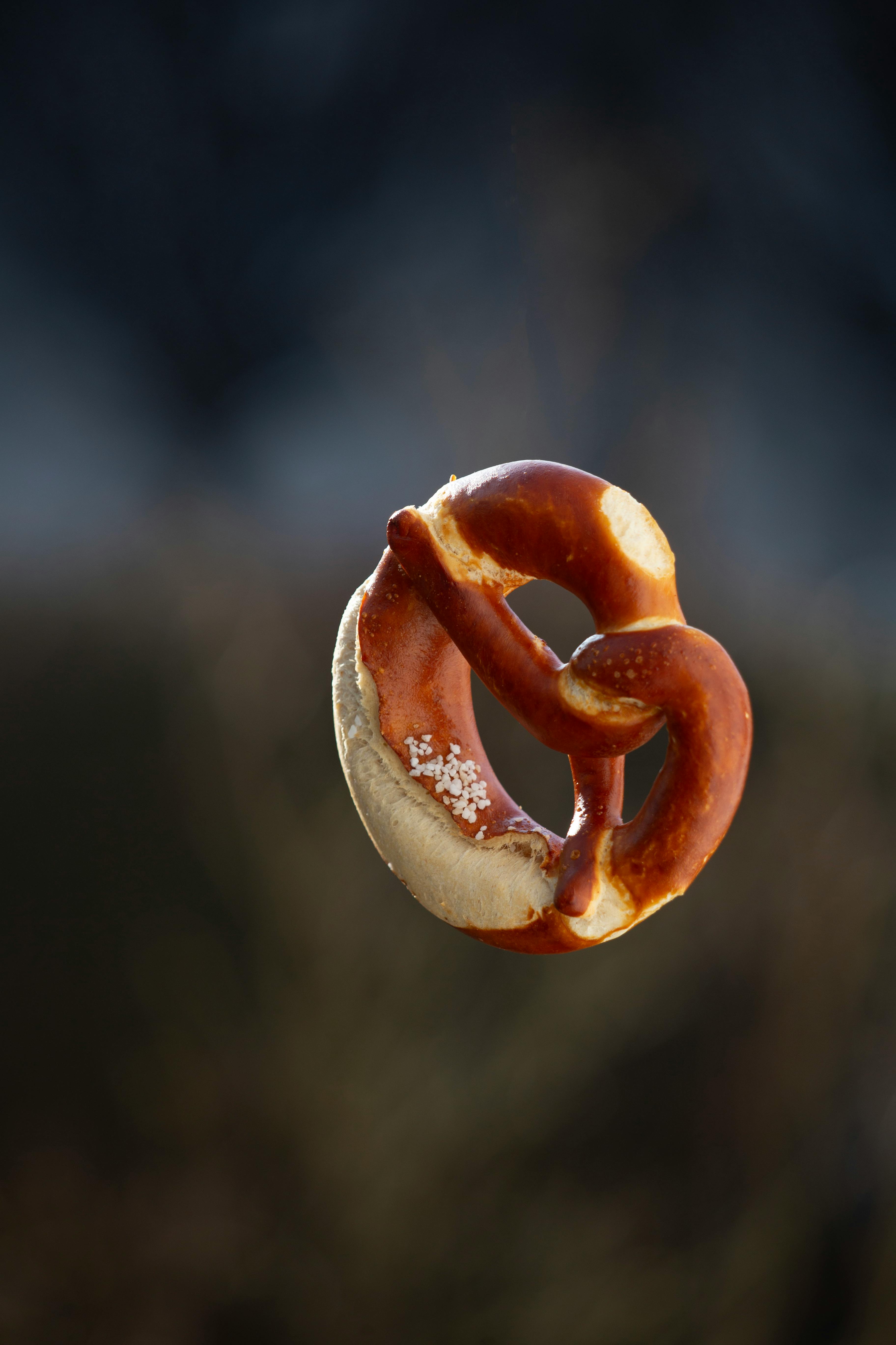 Flying Pretzel Against Blurred Background · Free Stock Photo