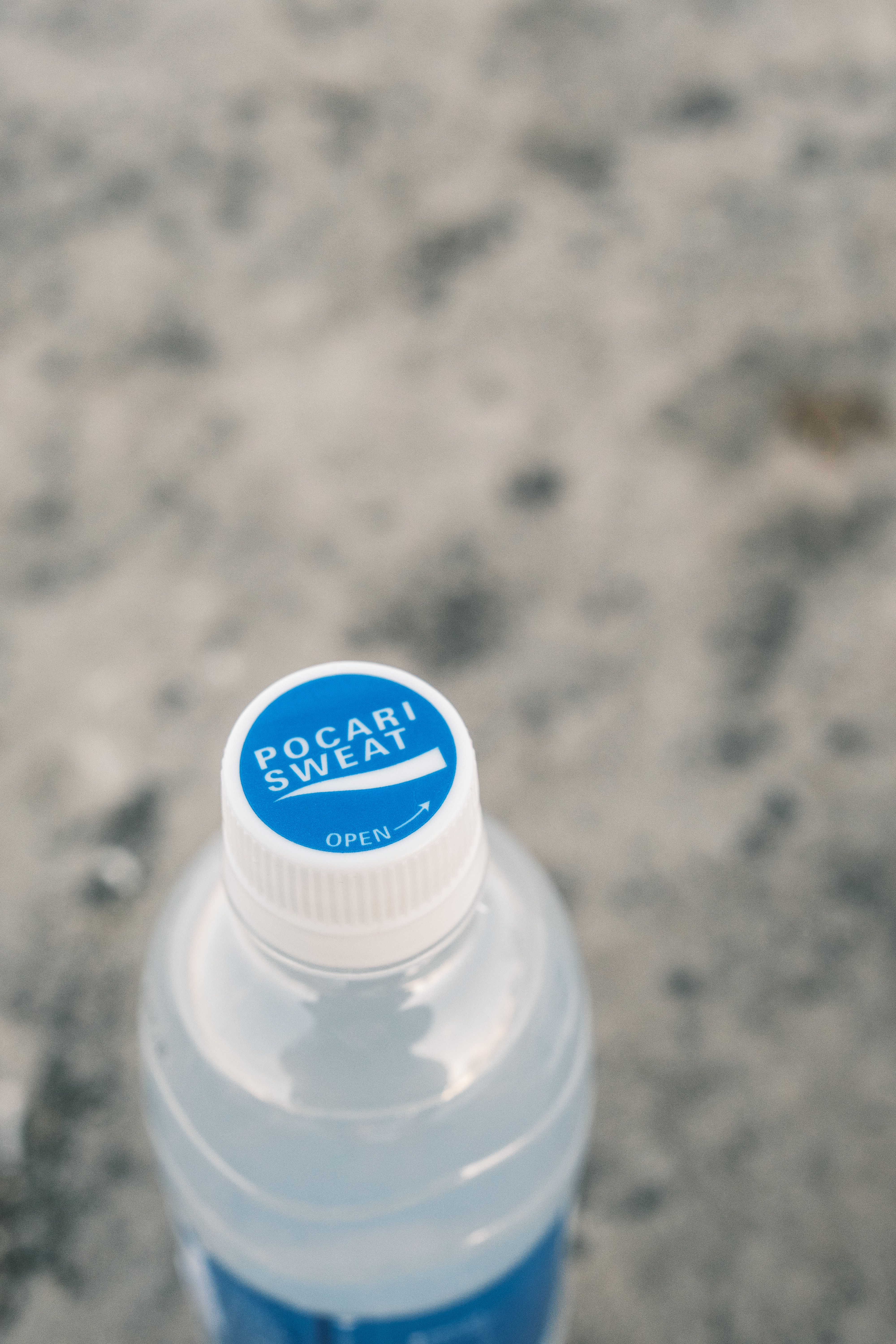 Close-up of Pocari Sweat Bottle Cap Outdoors · Free Stock Photo