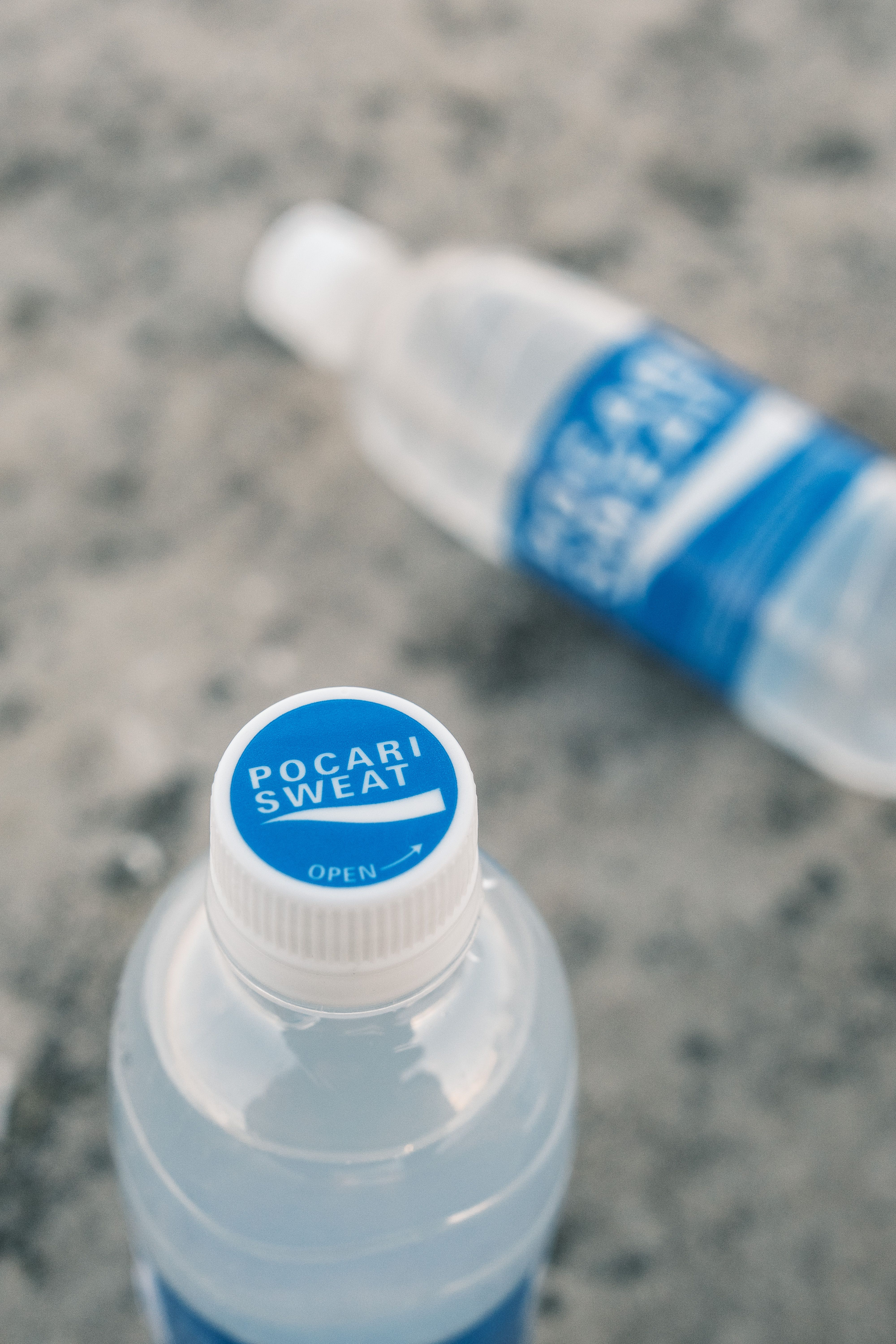 Close-up of Pocari Sweat Bottles on Ground · Free Stock Photo
