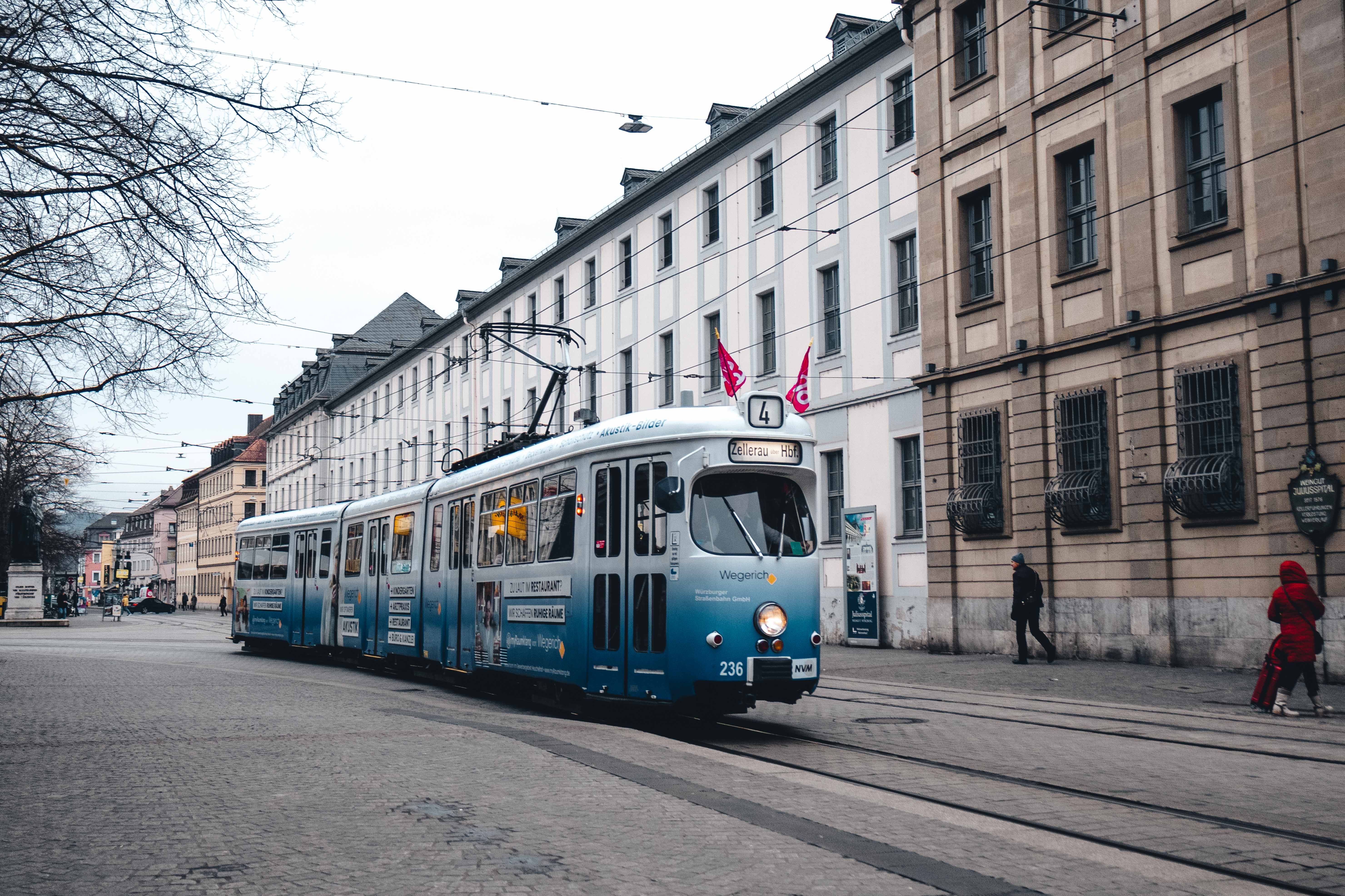 Historic Tram on Cobblestone Street in European City · Free Stock Photo