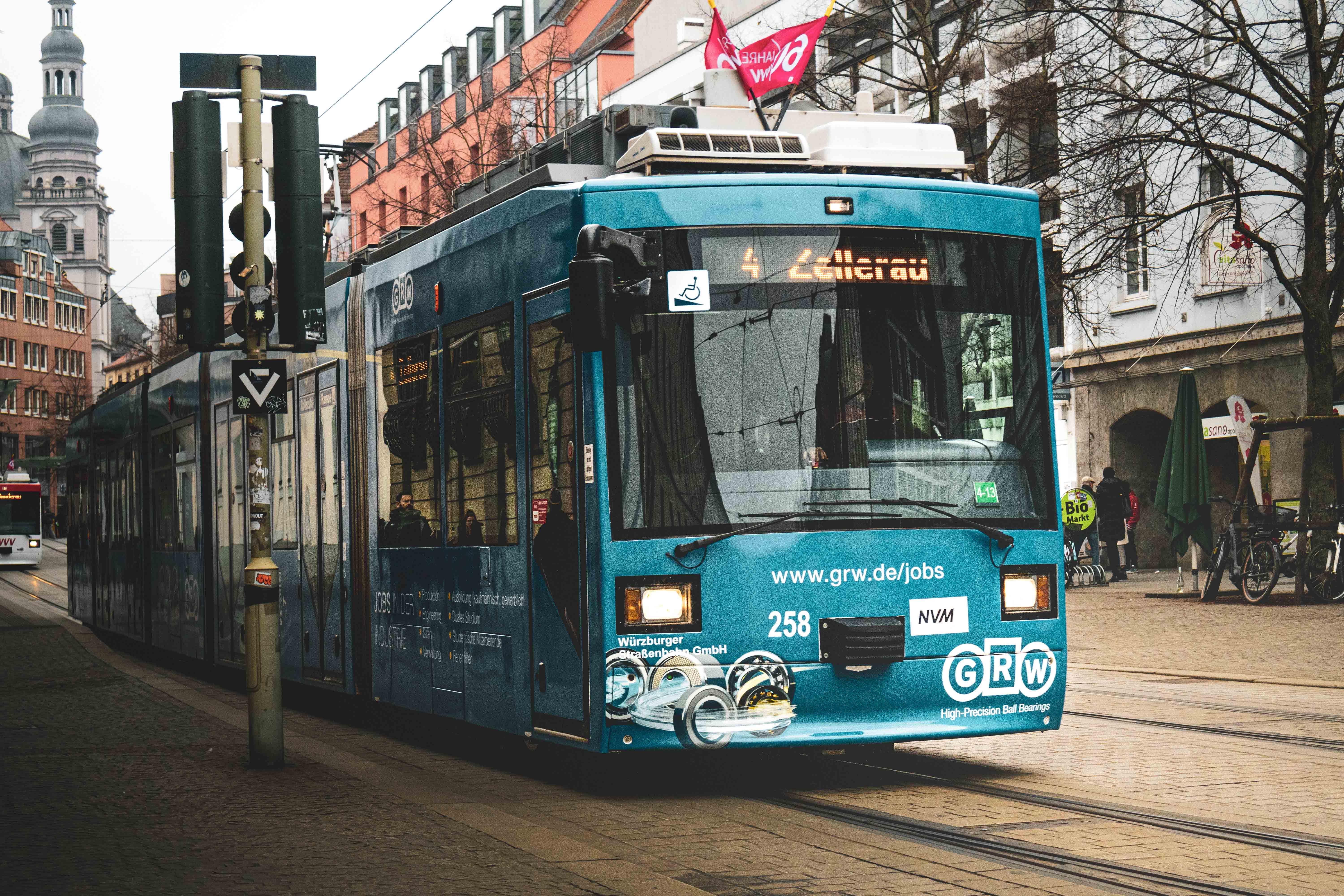 Urban Tram on a Bustling City Street · Free Stock Photo