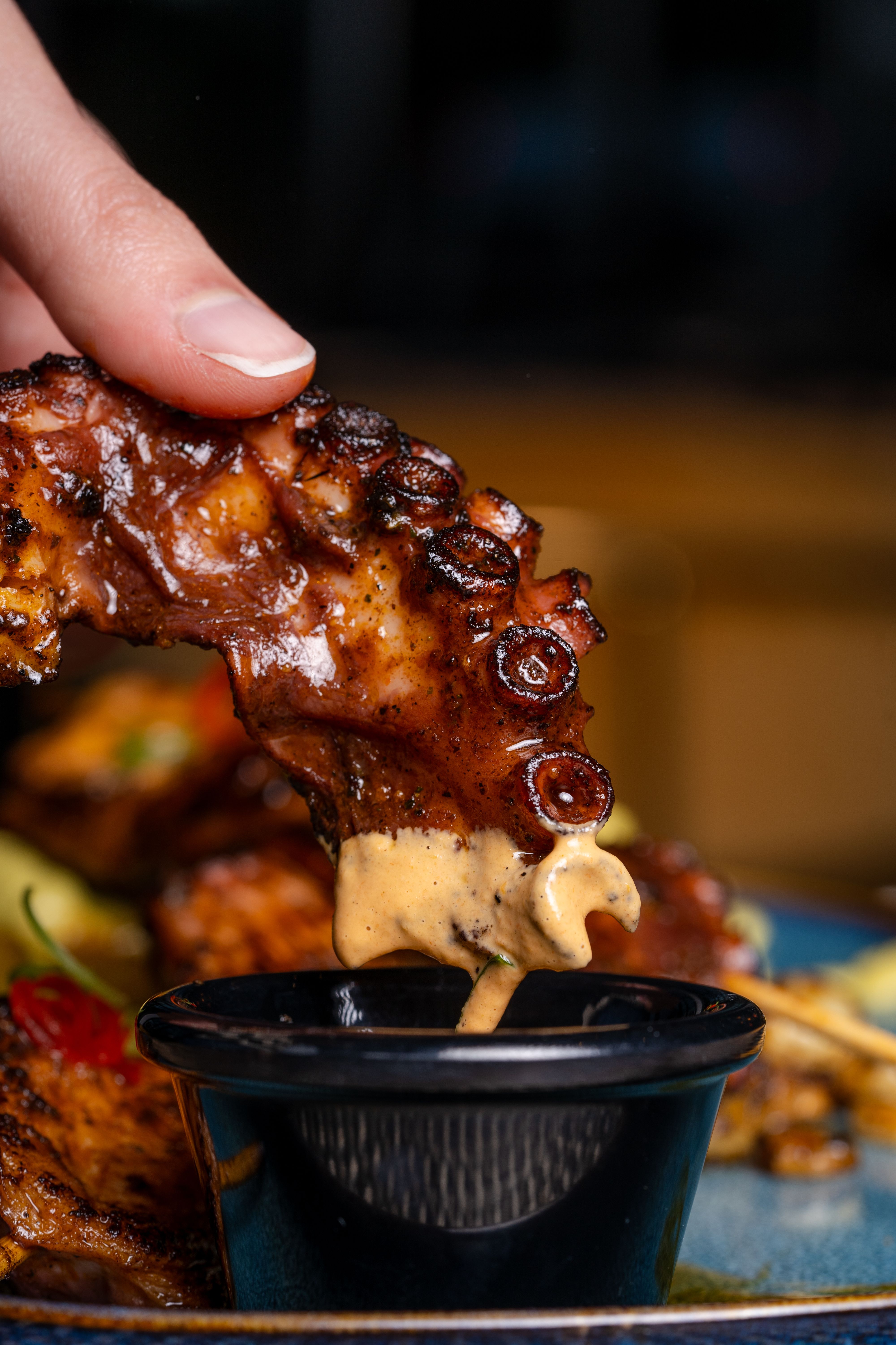 Grilled Octopus Tentacle Dipped in Creamy Sauce · Free Stock Photo