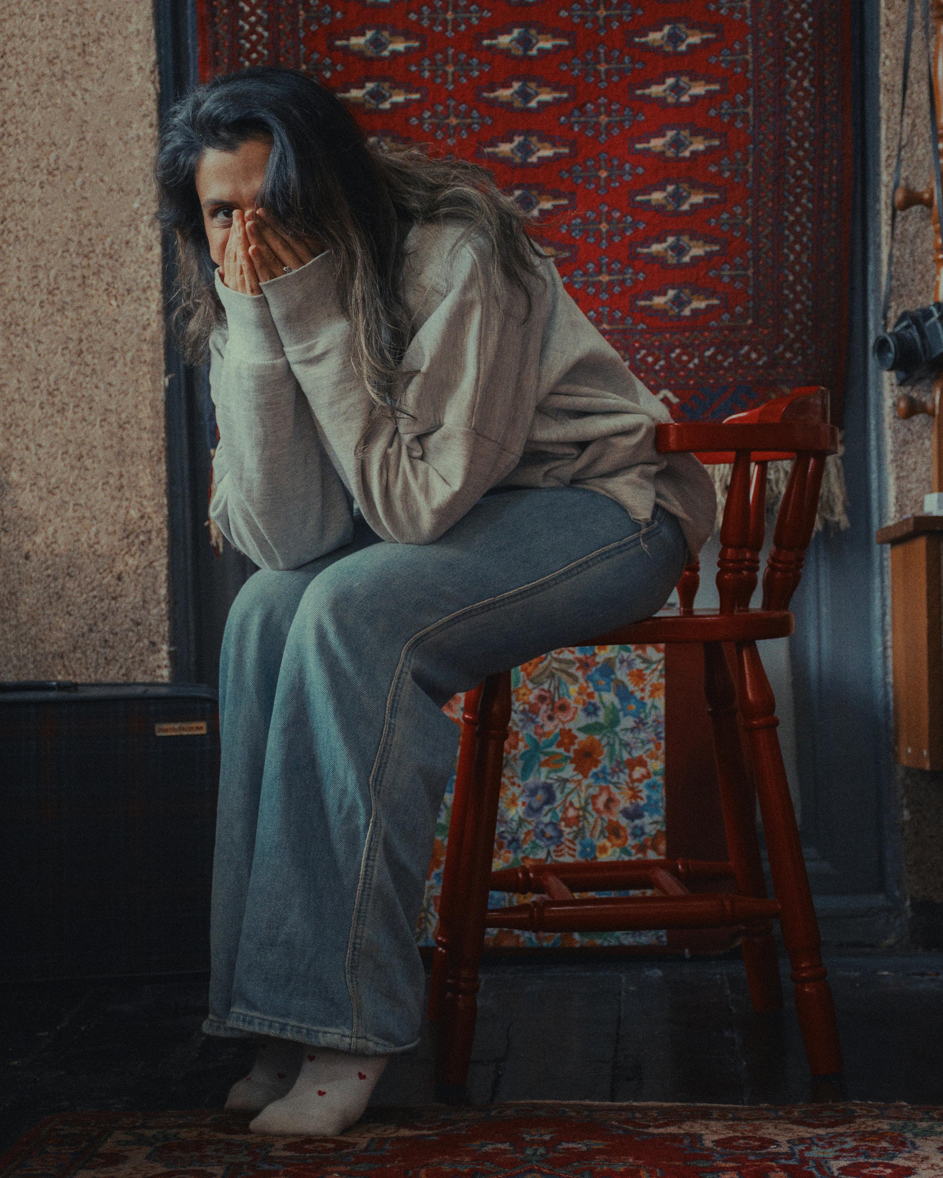 Portrait of a Woman in Introspective Pose · Free Stock Photo