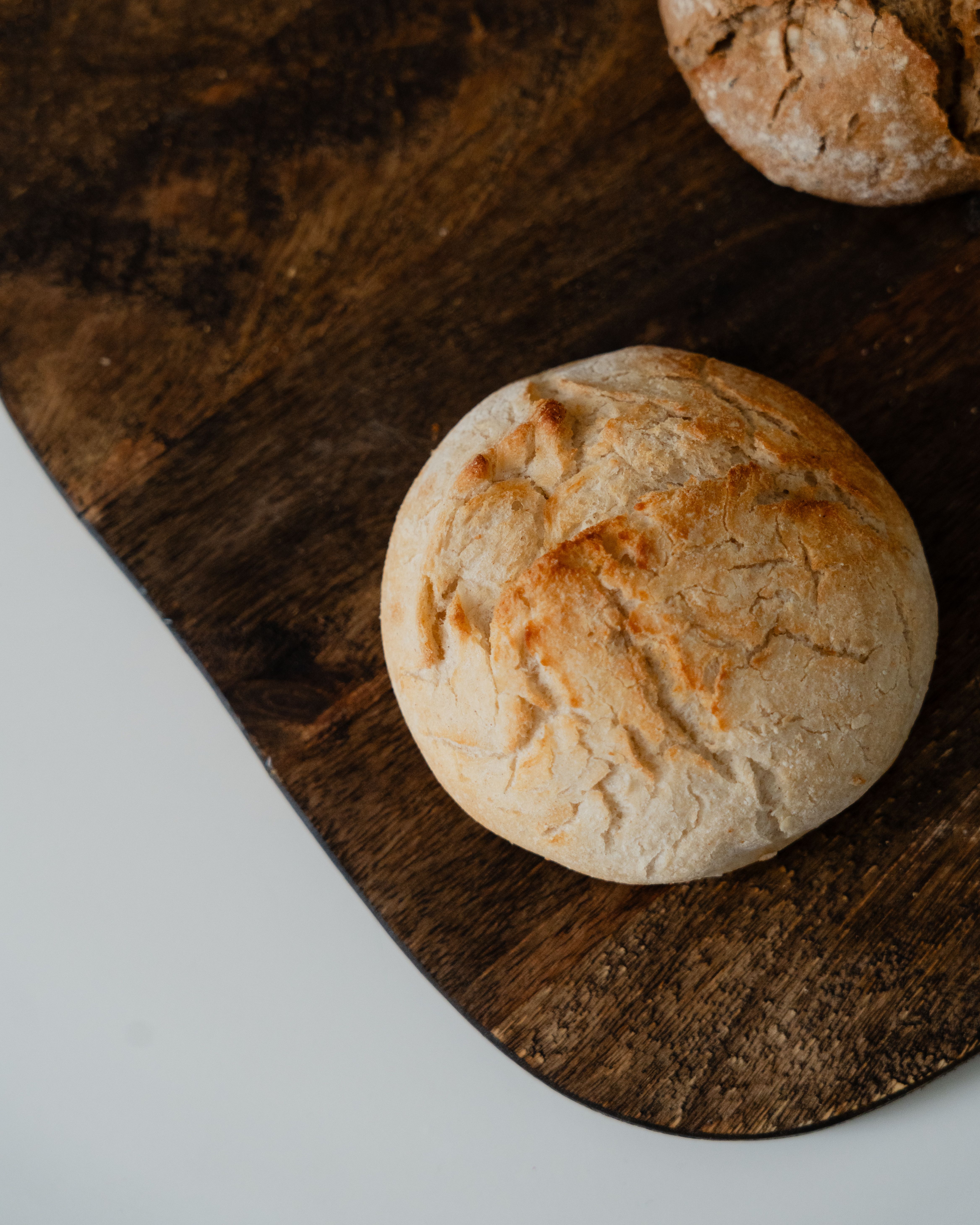 Rustic Artisan Breads on Wooden Surface · Free Stock Photo