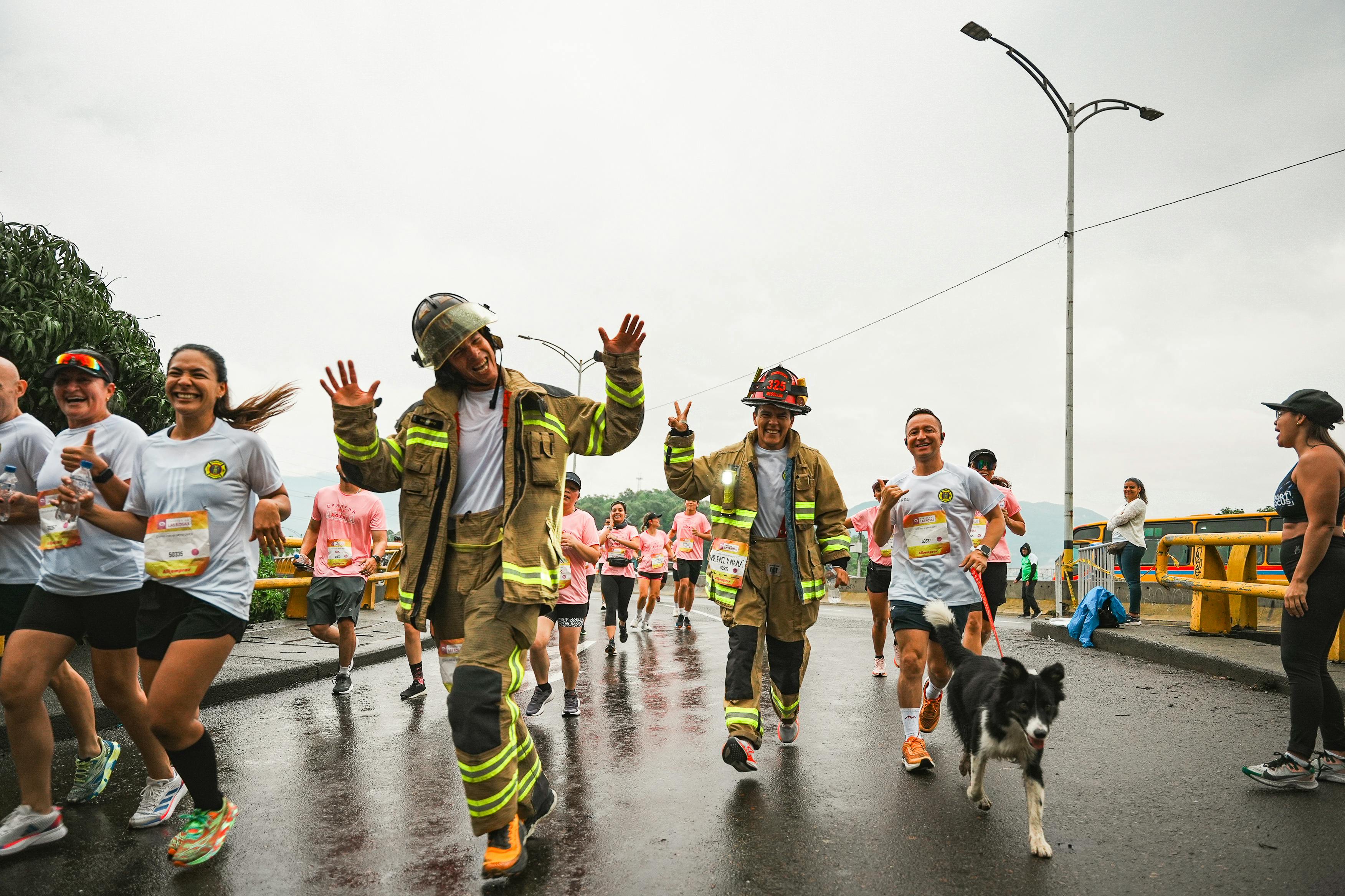 Joyful Group Running Marathon on a Rainy Day · Free Stock Photo