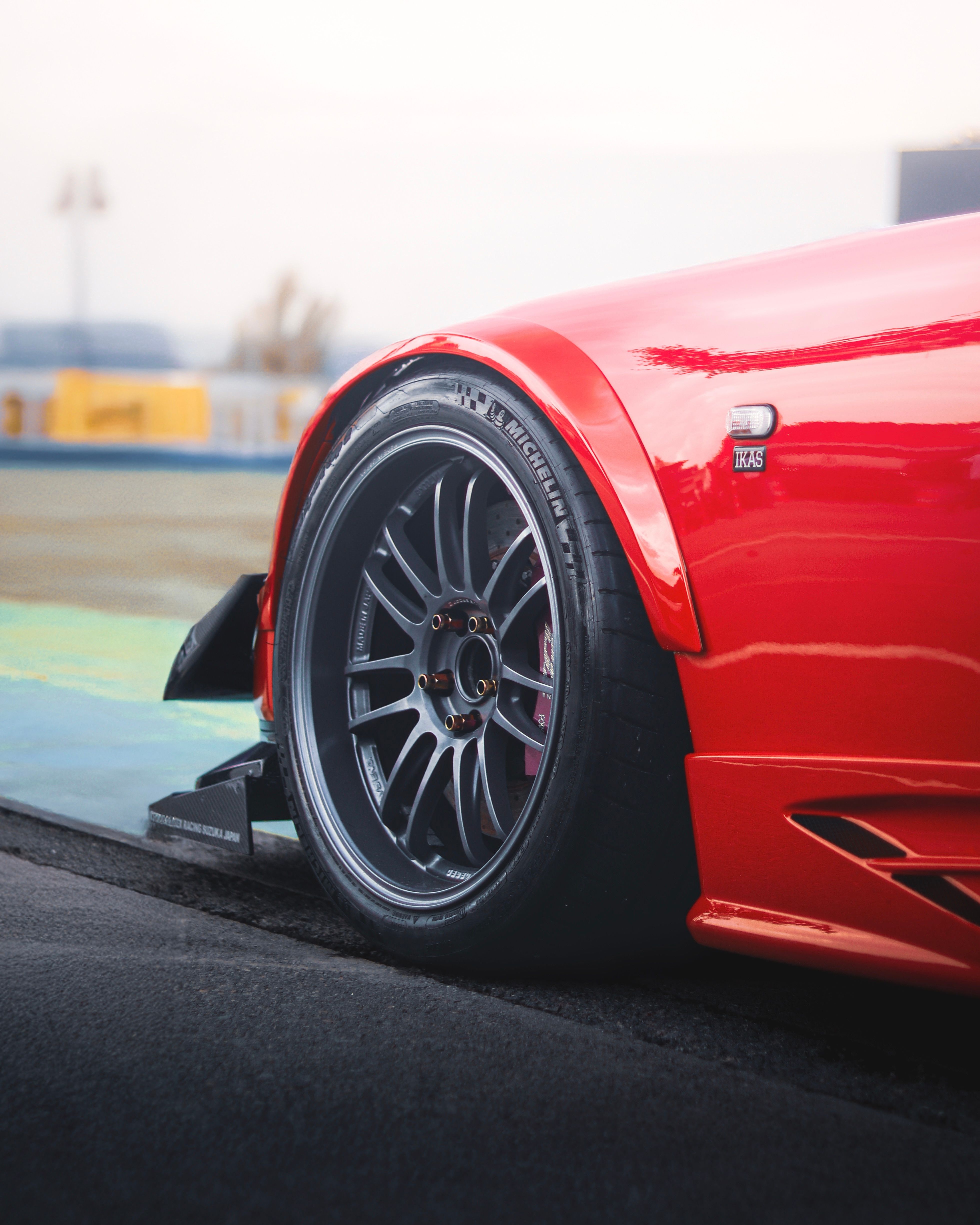 Close-Up of a Red Sports Car Wheel on Track · Free Stock Photo