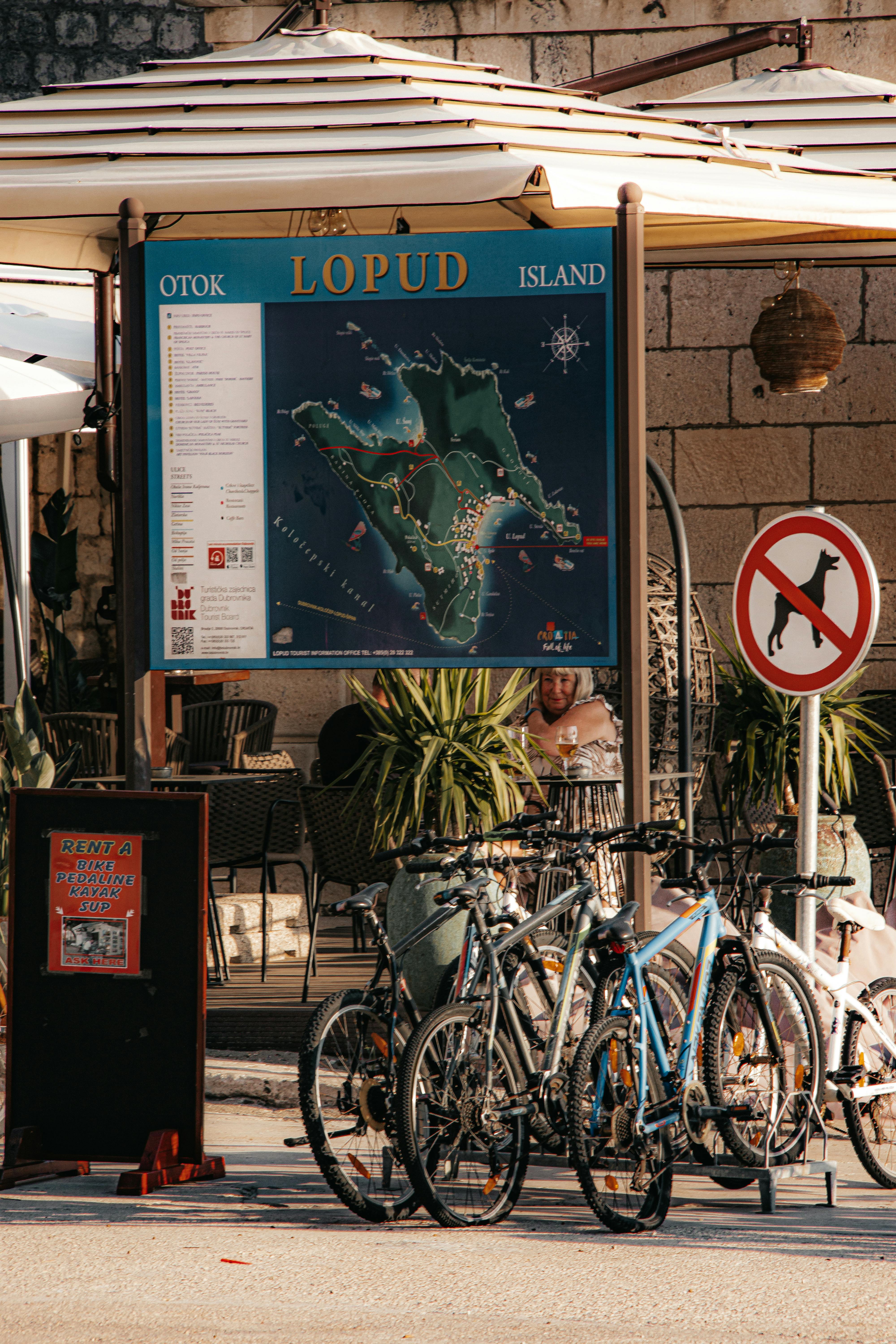 Bicycles and Map Sign in Lopud, Croatia · Free Stock Photo