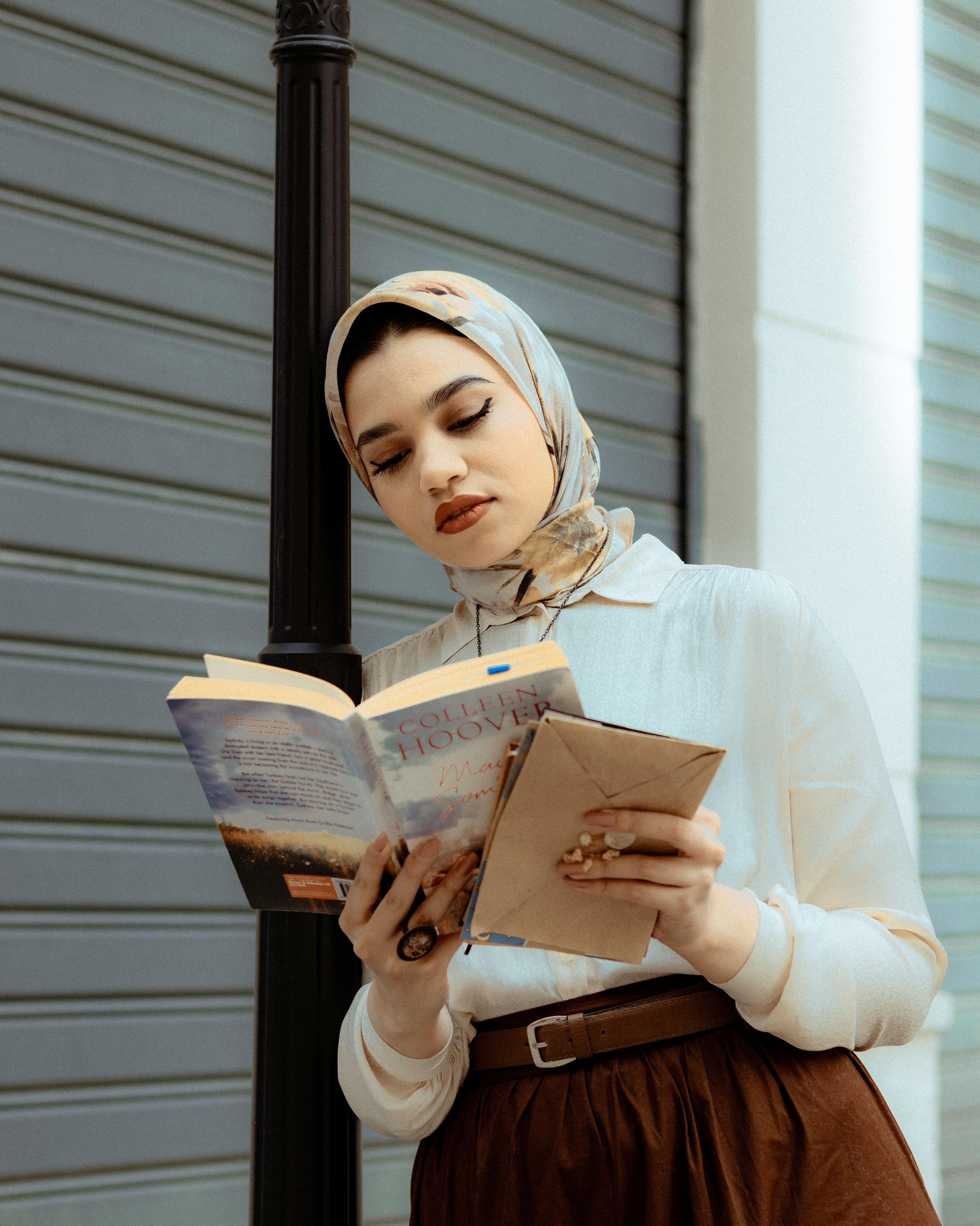 Young Woman Reading a Book in Stylish Outfit · Free Stock Photo