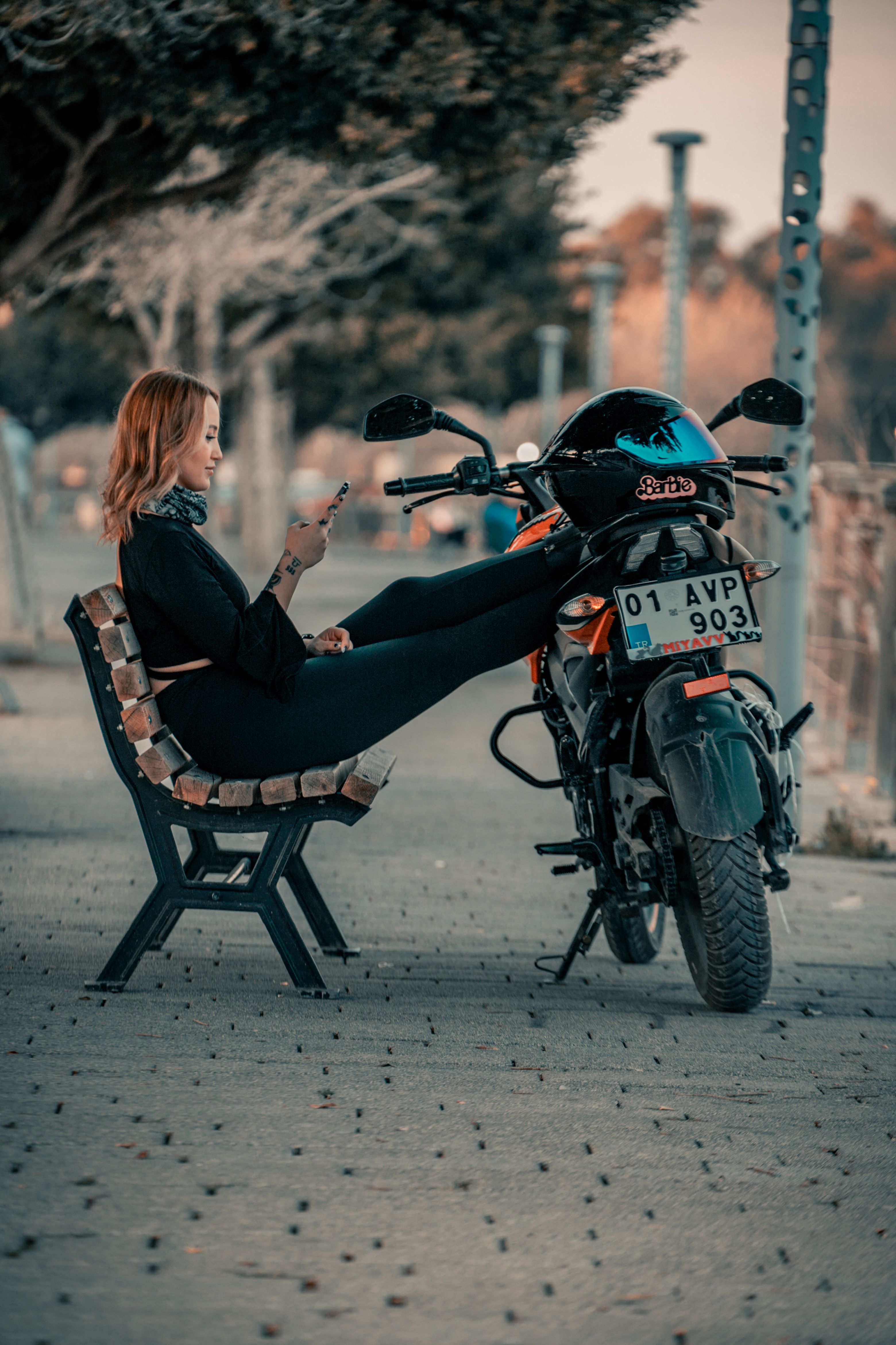 Young Woman Relaxing Beside Motorcycle · Free Stock Photo