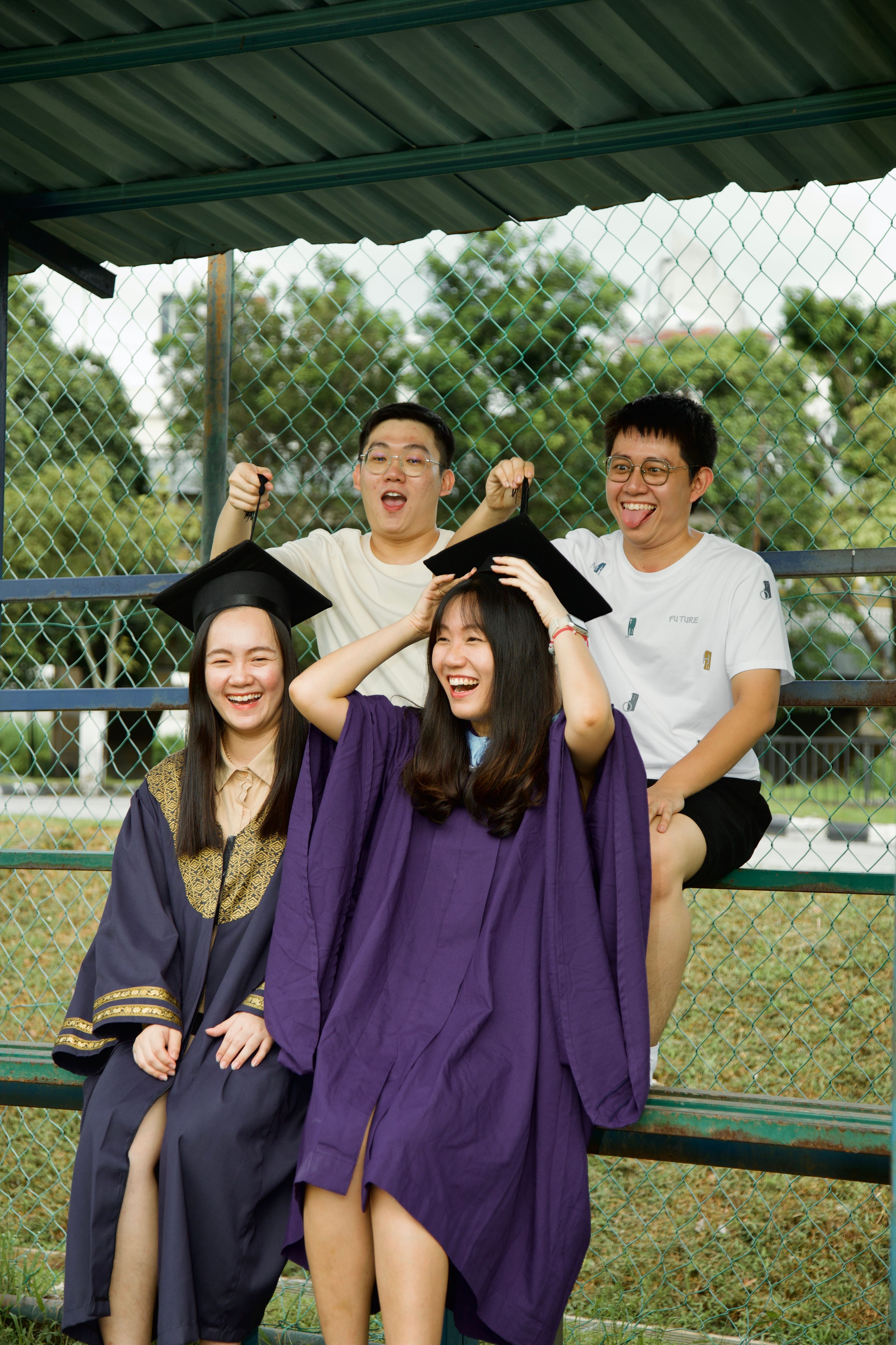 Cheerful Graduation Celebration Outdoors · Free Stock Photo