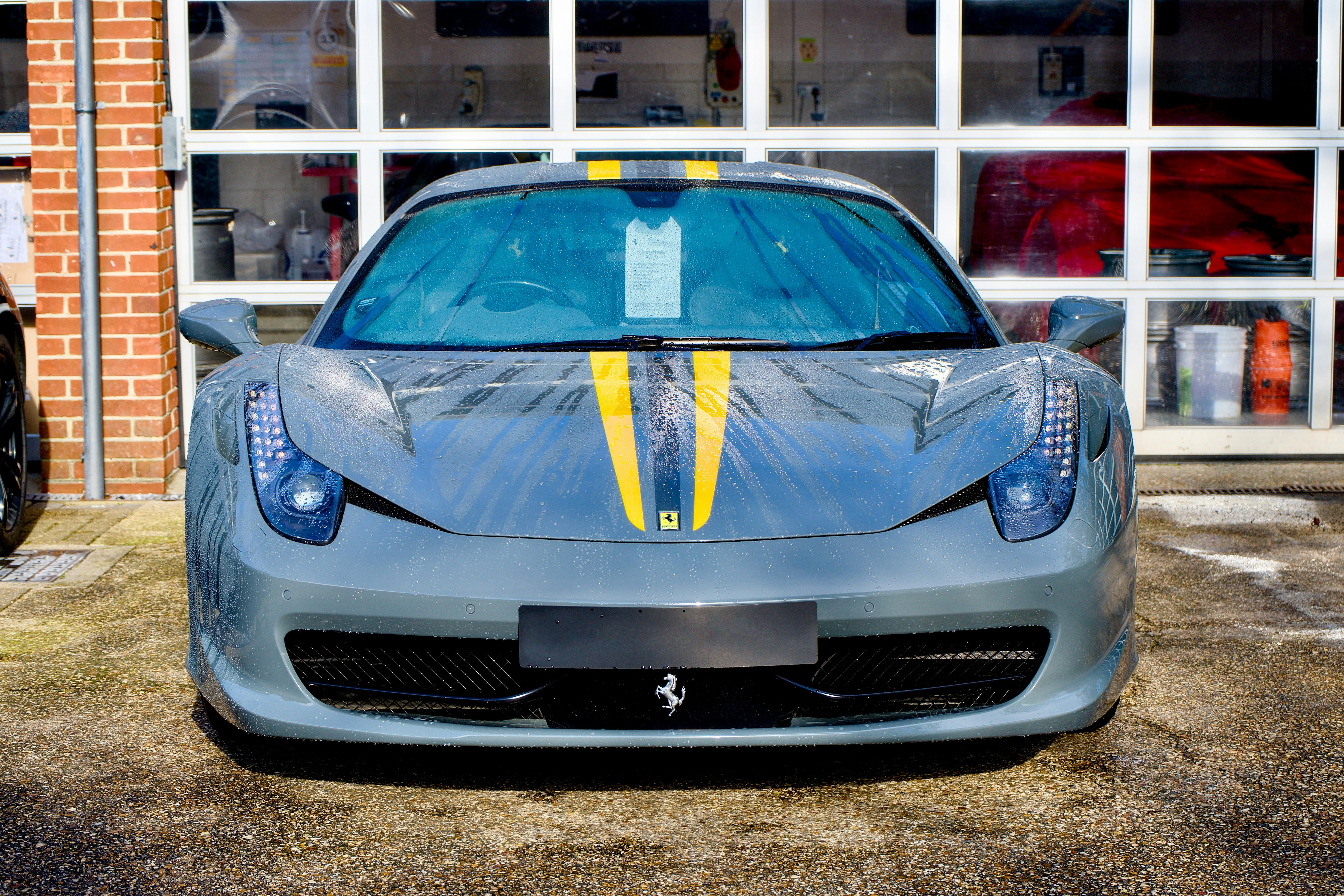 Luxury Sports Car with Yellow Racing Stripes · Free Stock Photo