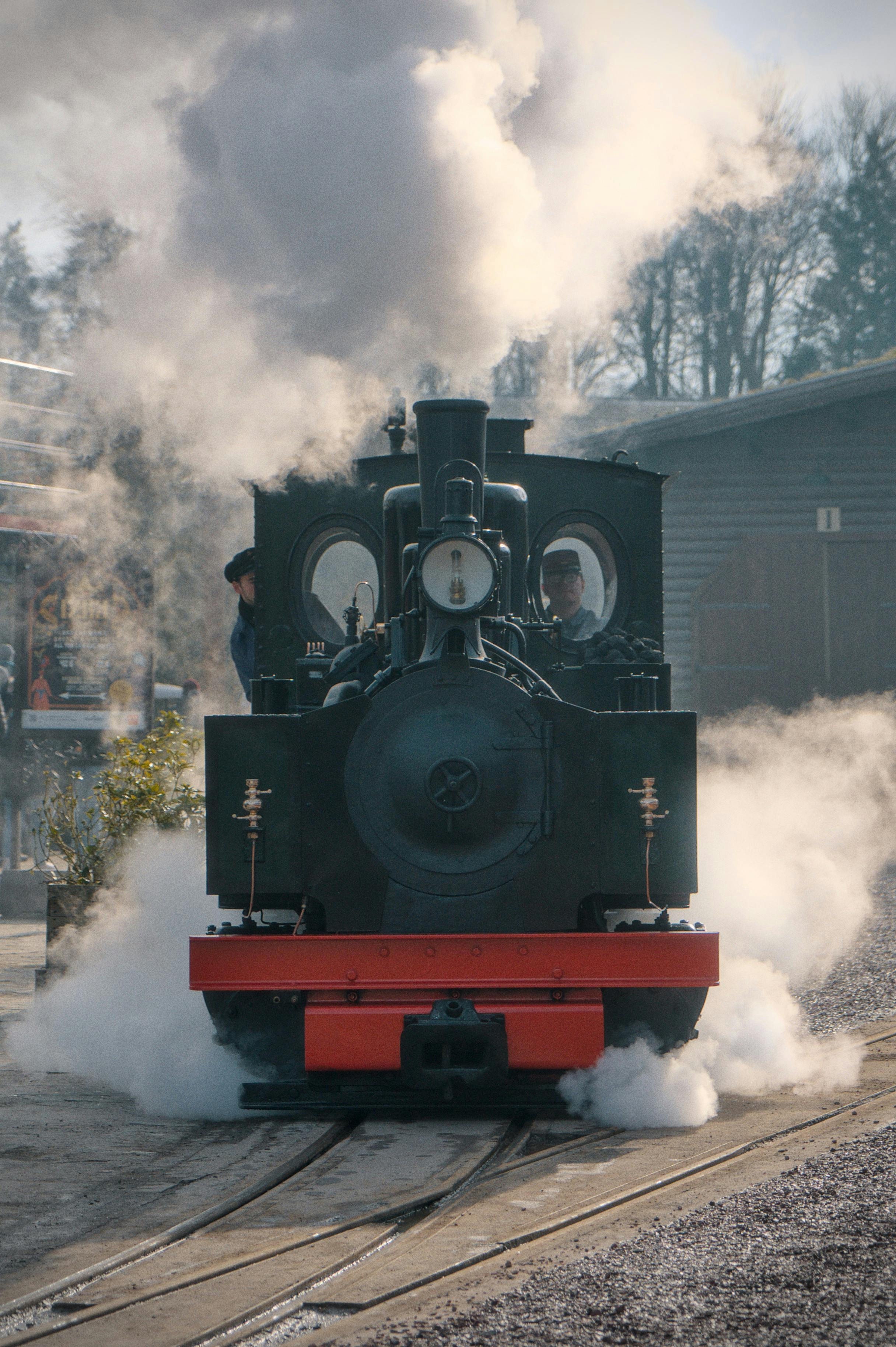 Vintage Steam Locomotive in Action at Railway Station · Free Stock Photo