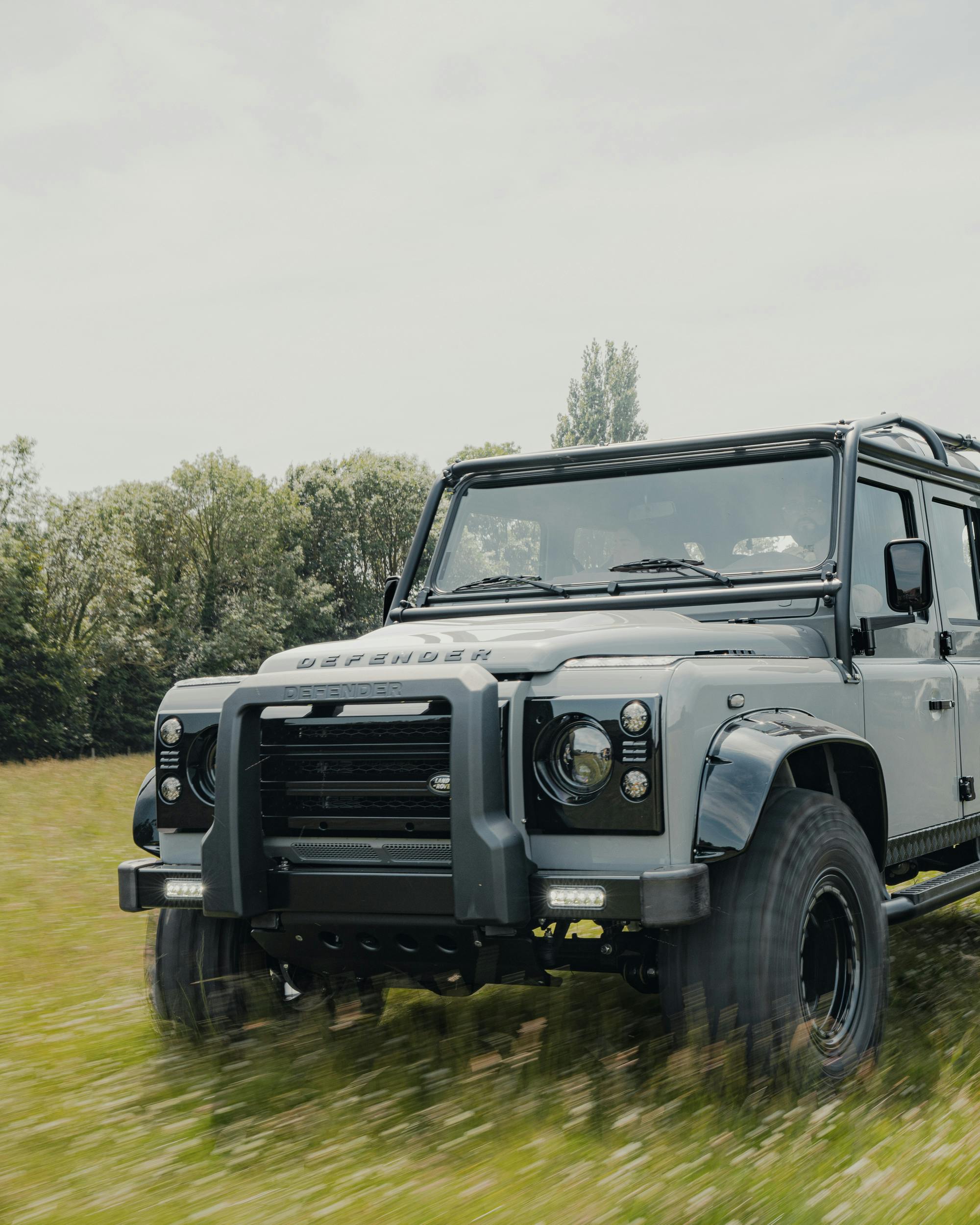 Off-Road 4x4 Vehicle in Lush Green Field · Free Stock Photo