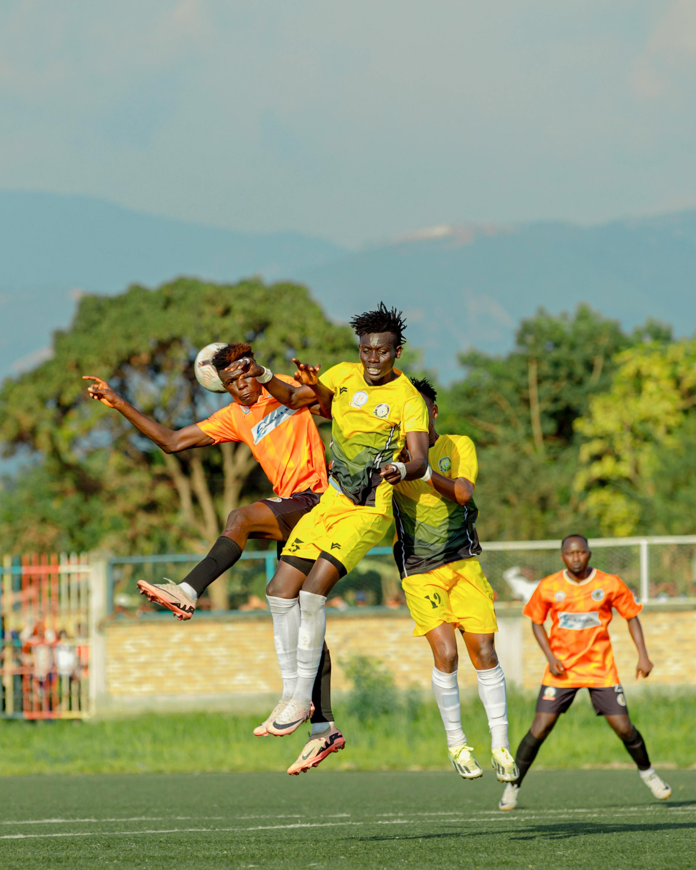 Intense Soccer Match Jump for Ball Outdoors · Free Stock Photo
