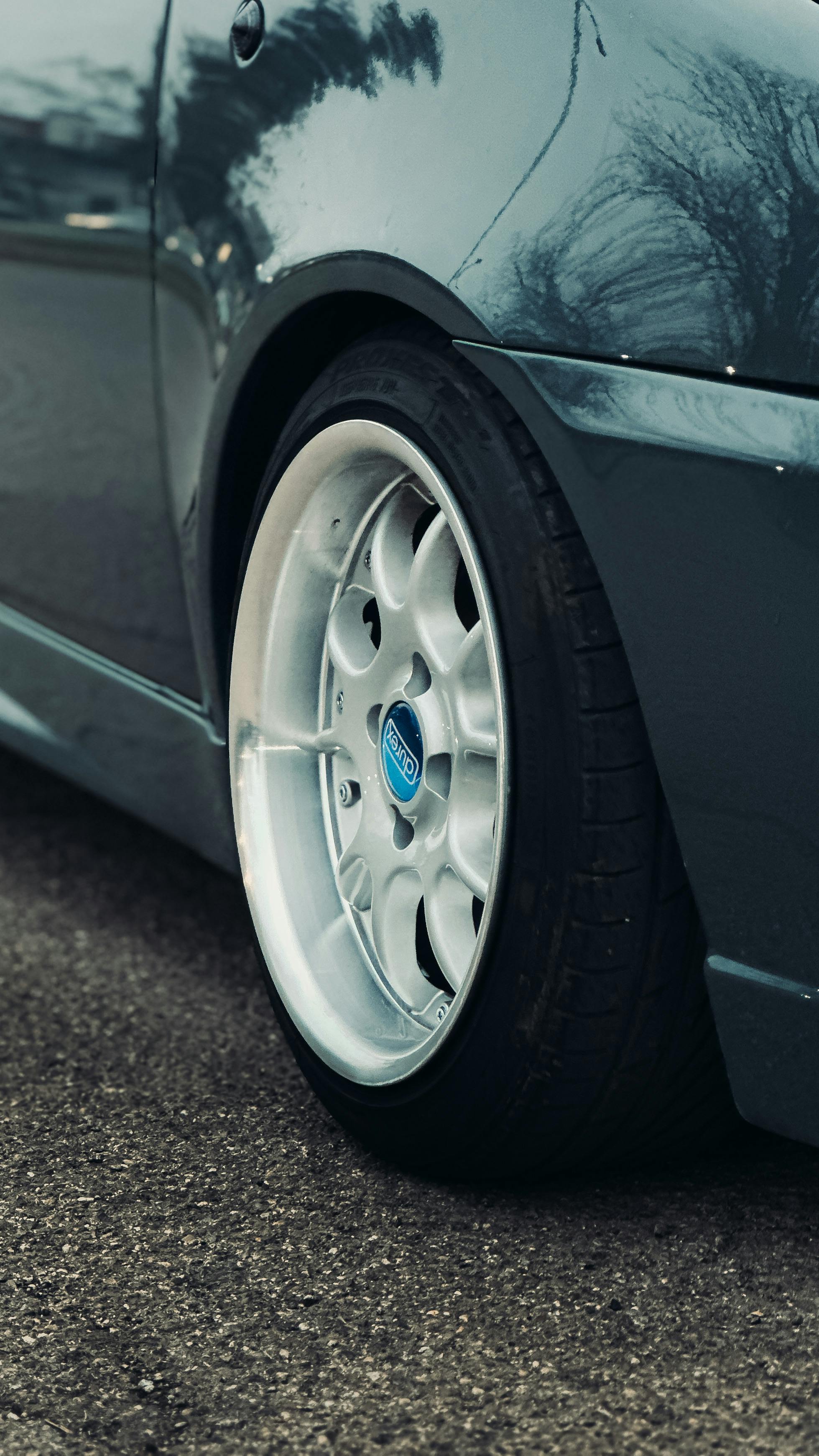Close-up of Car Wheel on Asphalt Road · Free Stock Photo