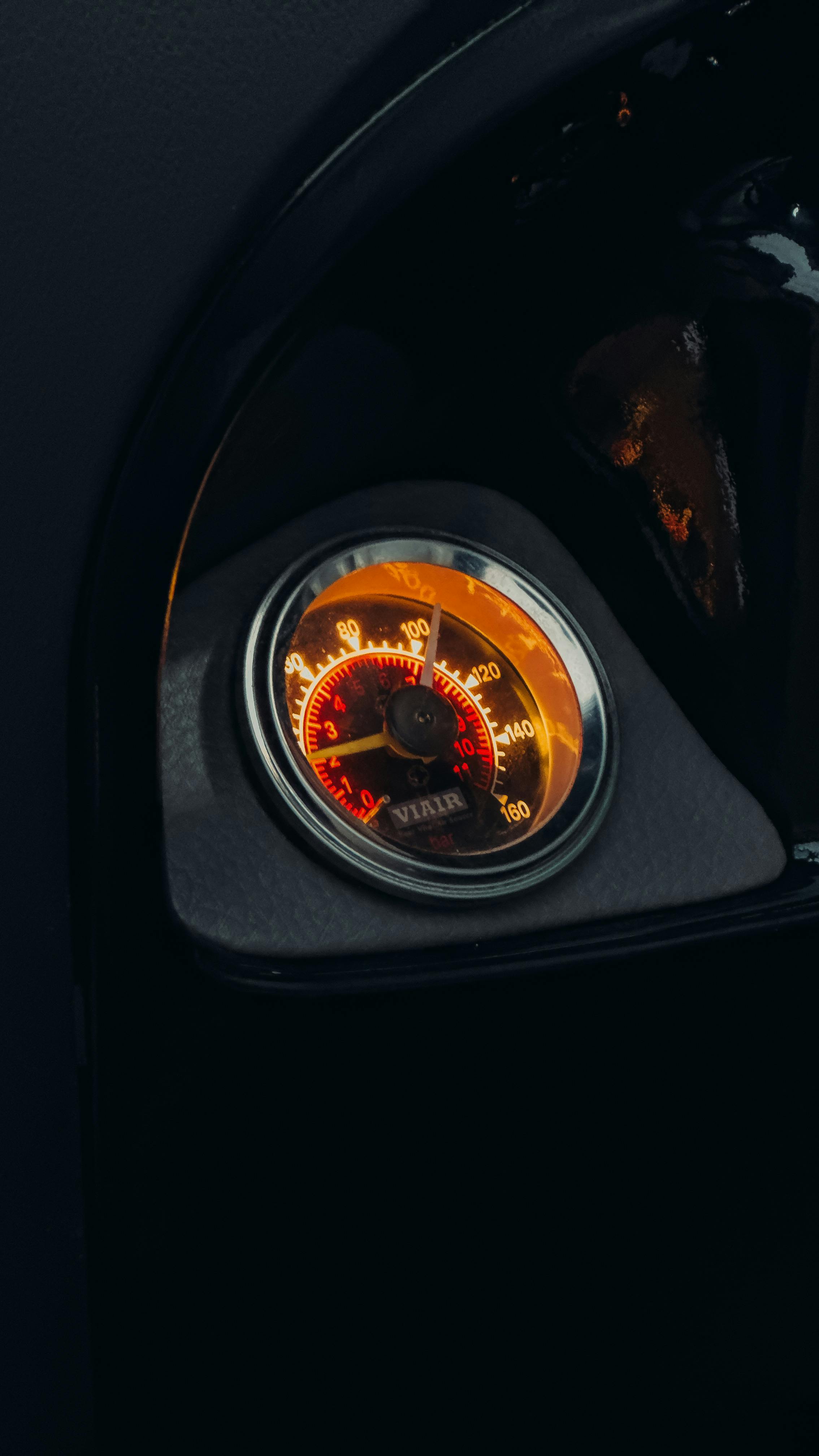 Close-up of Car Speedometer with Orange Backlight · Free Stock Photo