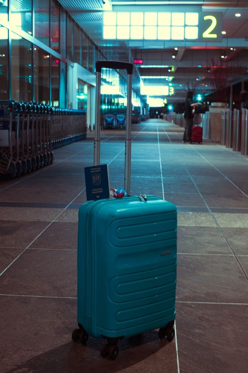 Blue Suitcase in Empty Airport Terminal · Free Stock Photo
