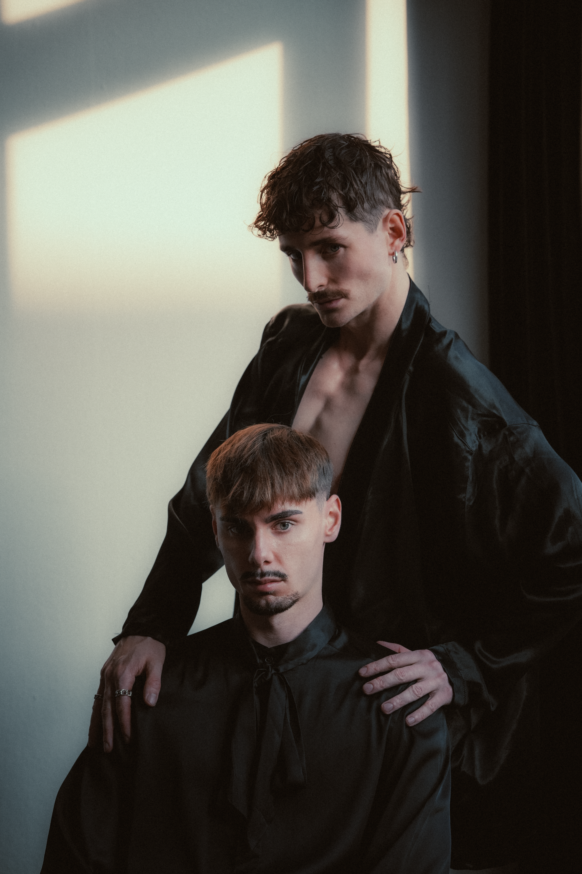 Elegant Portrait of Two Men in Dramatic Light · Free Stock Photo