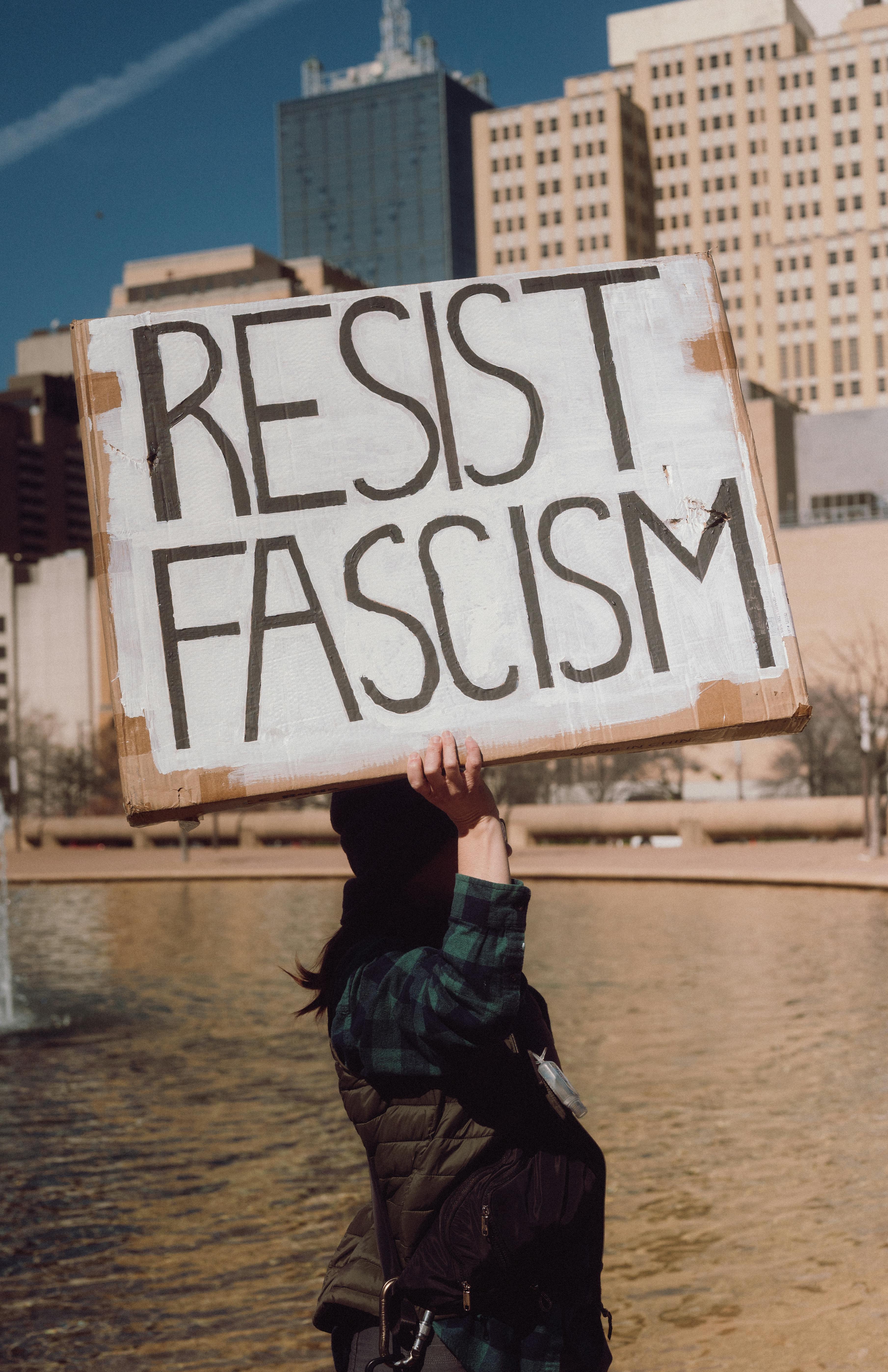 Woman Holding 'Resist Fascism' Sign at Protest · Free Stock Photo