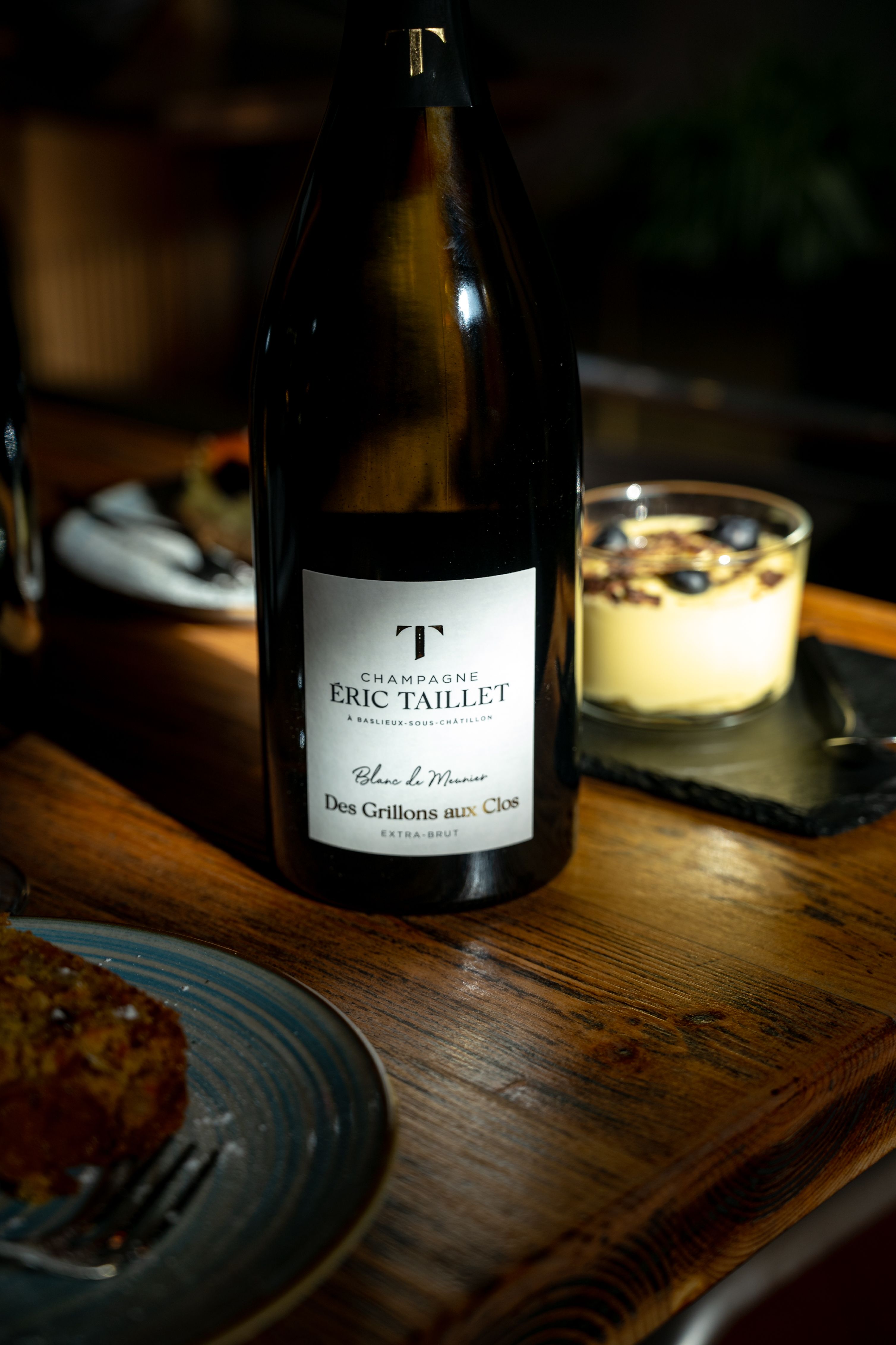 Elegant Champagne Bottle on Rustic Table · Free Stock Photo