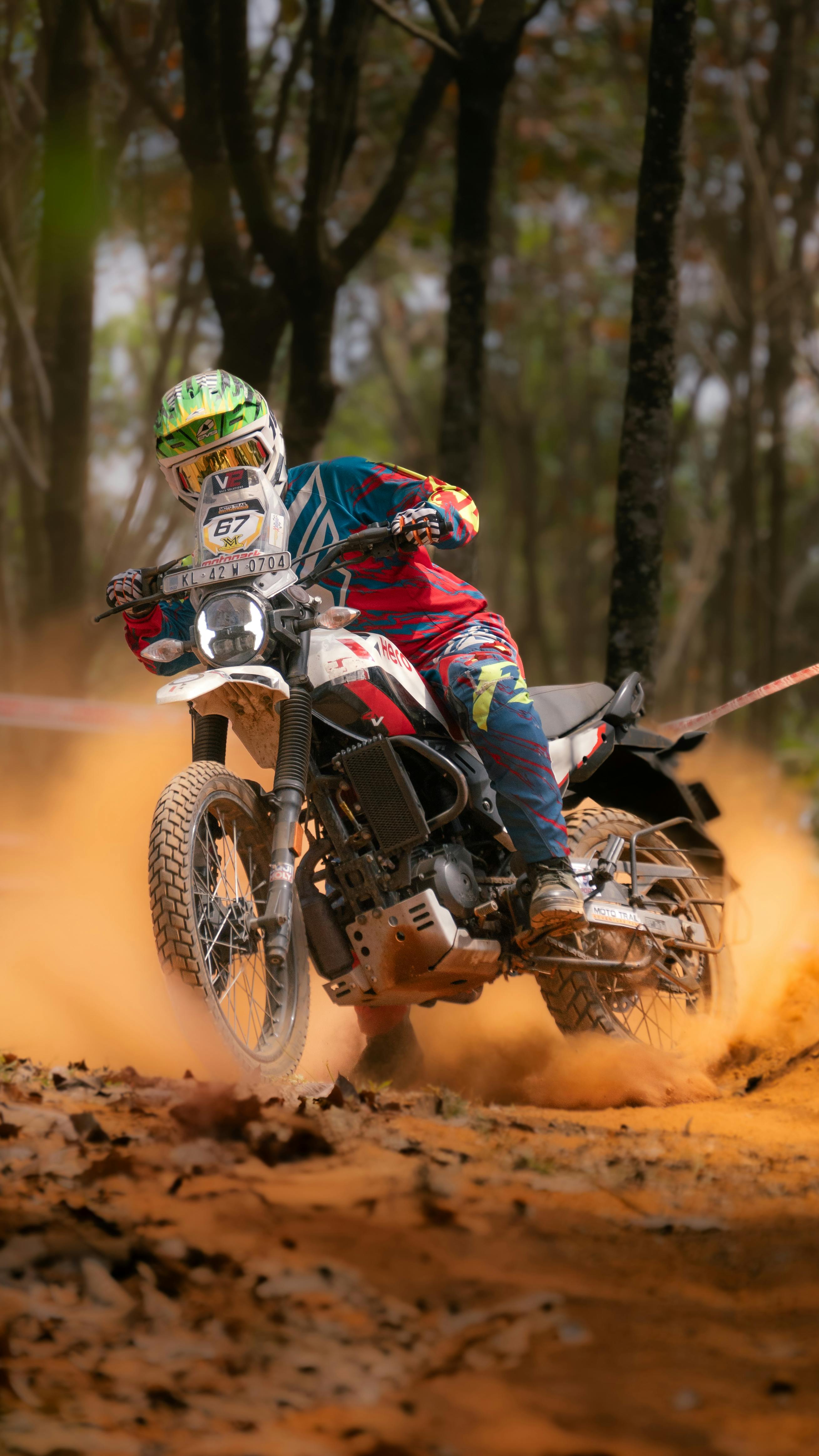 Dynamic Off-Road Motorcycle Racing Action Shot · Free Stock Photo