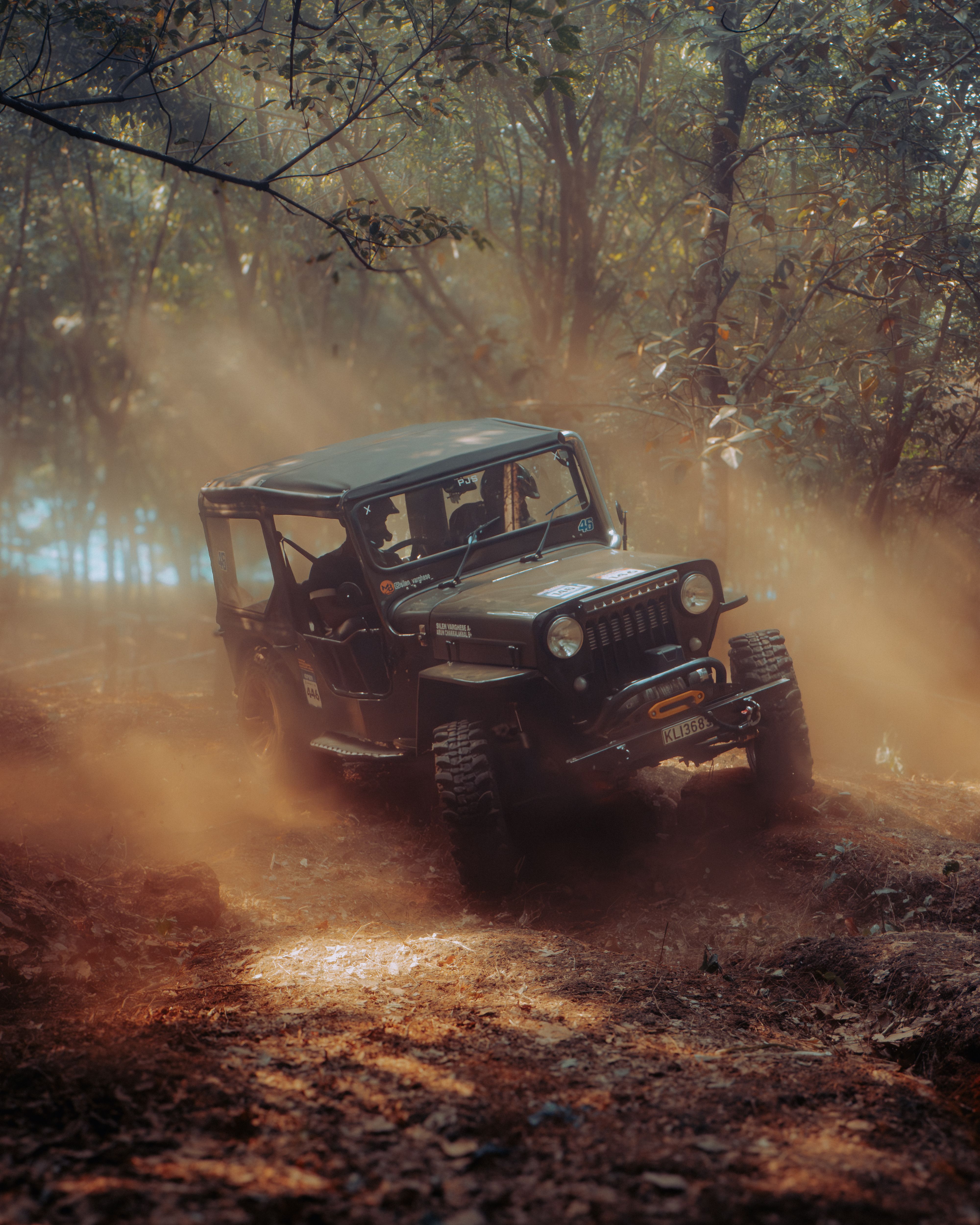 Off-Road Adventure: Jeep Navigating Forest Terrain · Free Stock Photo
