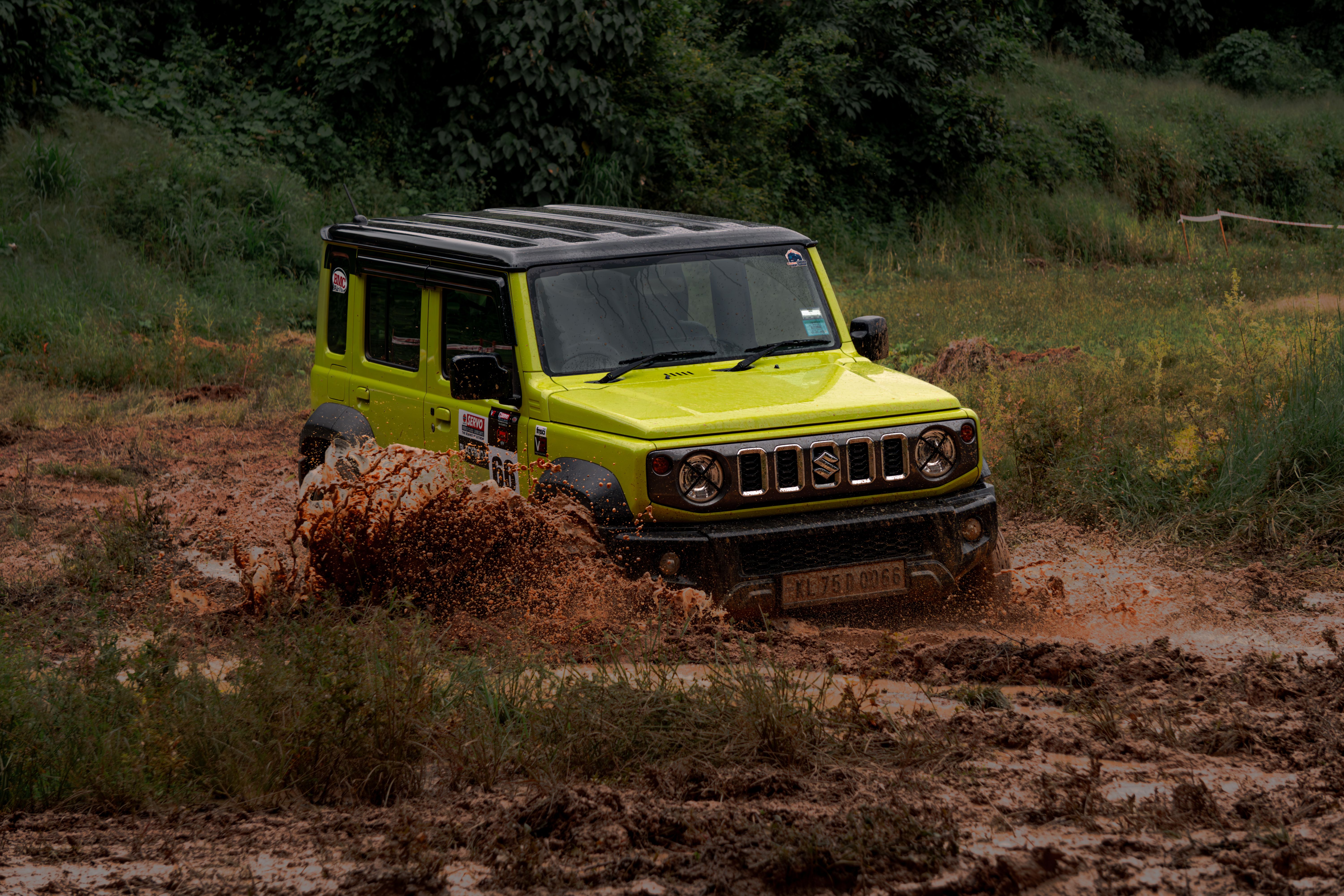 Lime Green SUV Off-Road Adventure in Muddy Terrain · Free Stock Photo