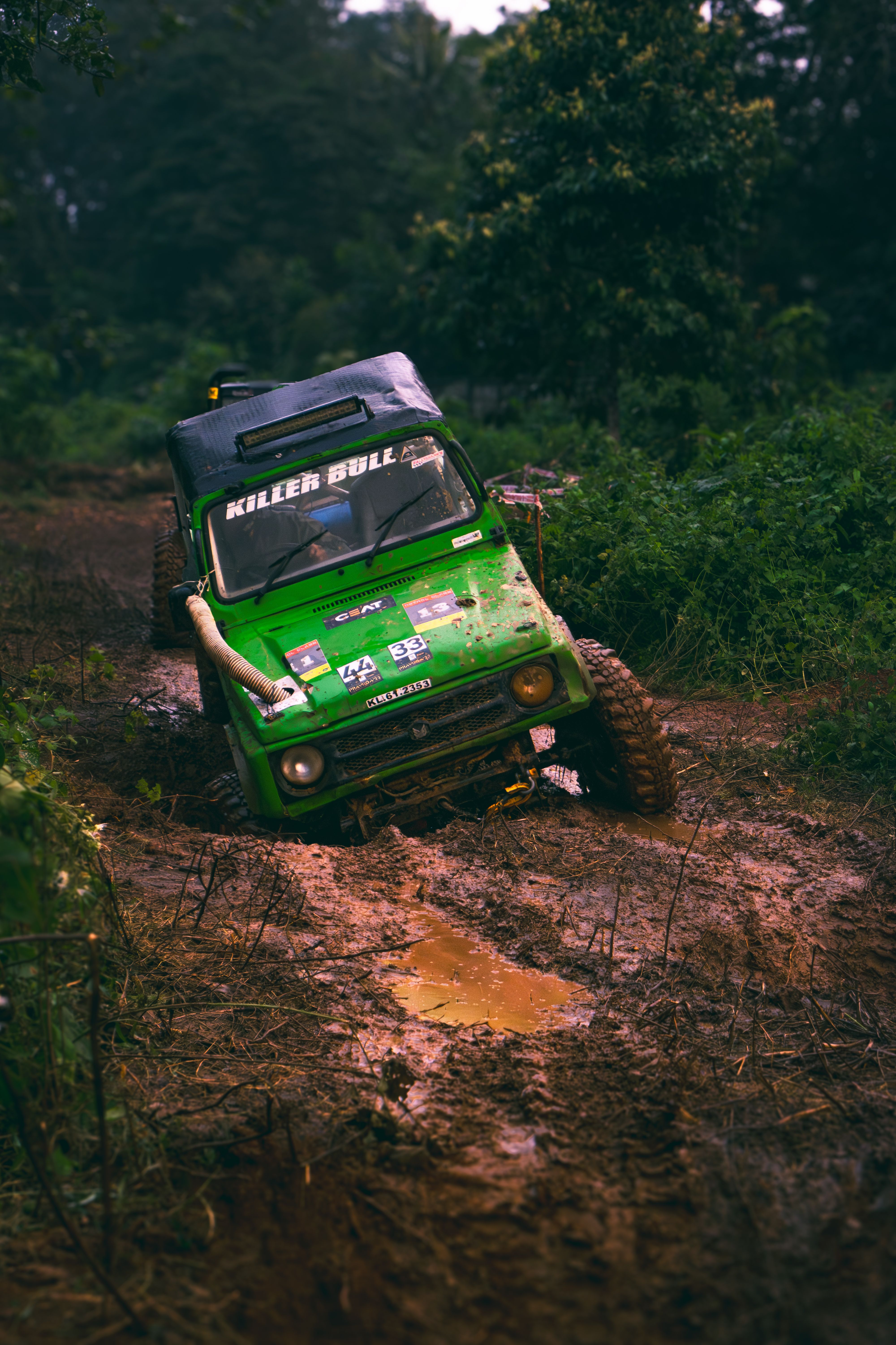 Green Off-Road Vehicle in Muddy Terrain Adventure · Free Stock Photo