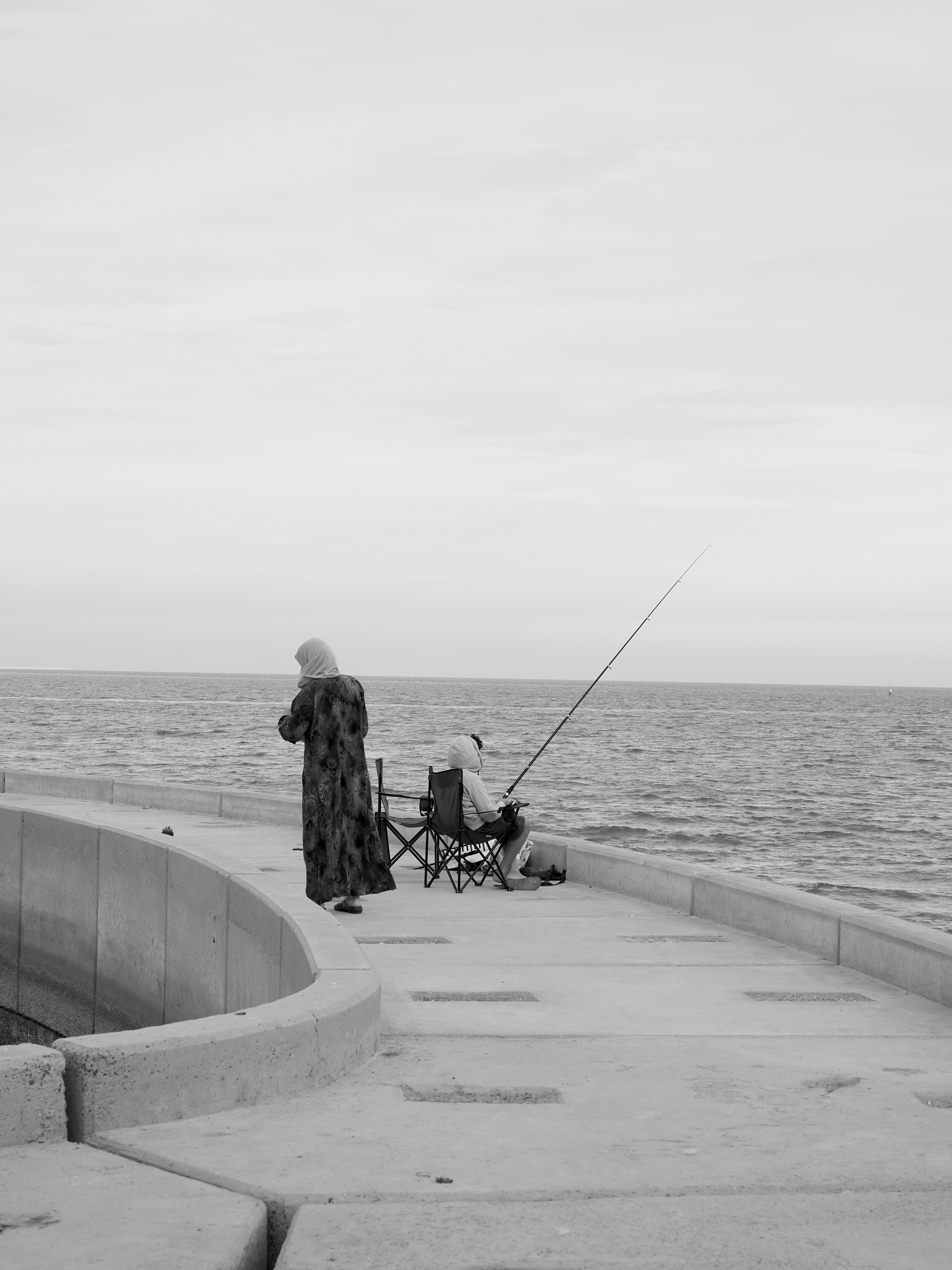 Serene Fishing Scene at Doha Seafront · Free Stock Photo