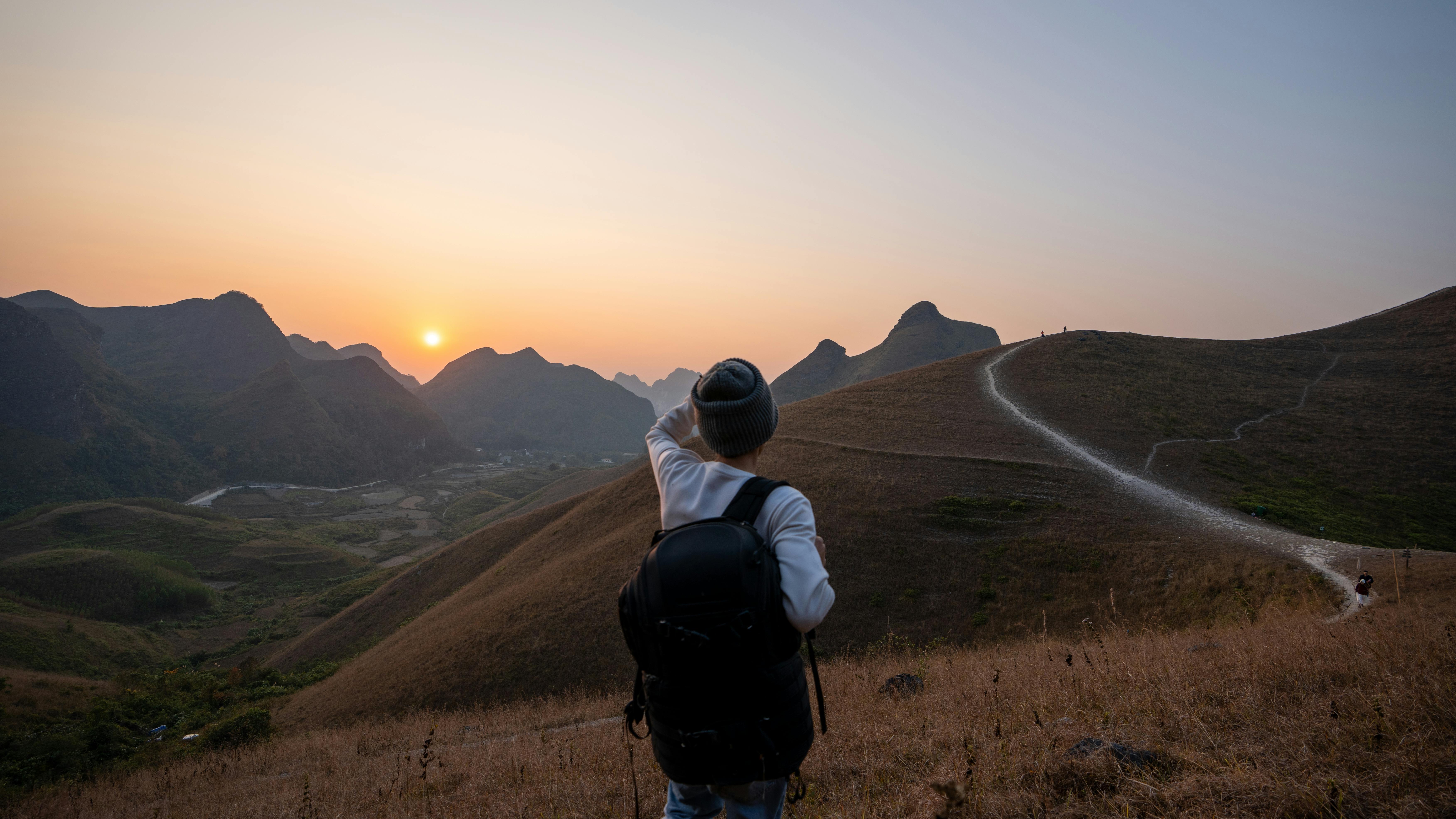 Adventurer Enjoying a Sunset Mountain View · Free Stock Photo