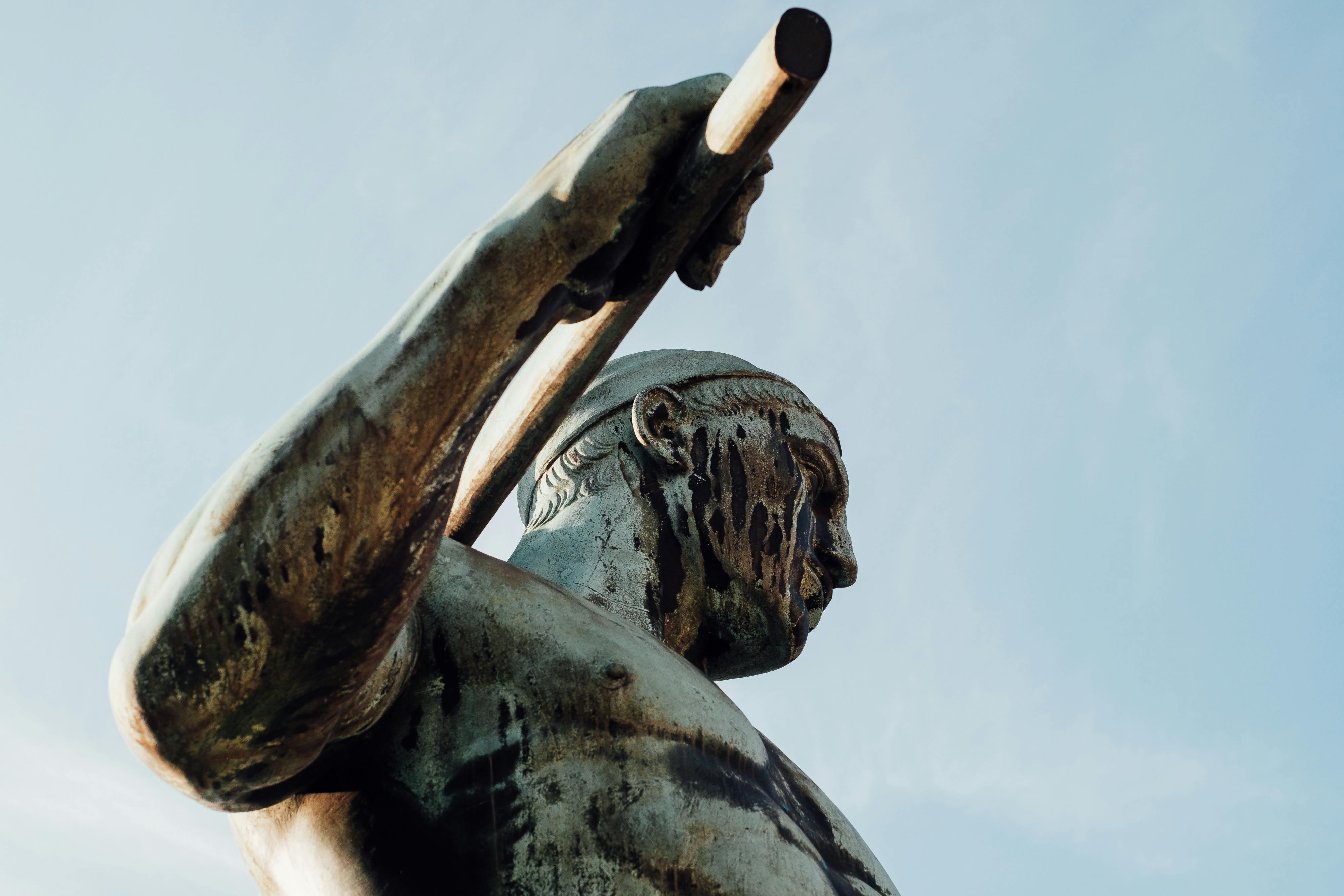 Close-up Perspective of Bronze Statue Holding Rod · Free Stock Photo