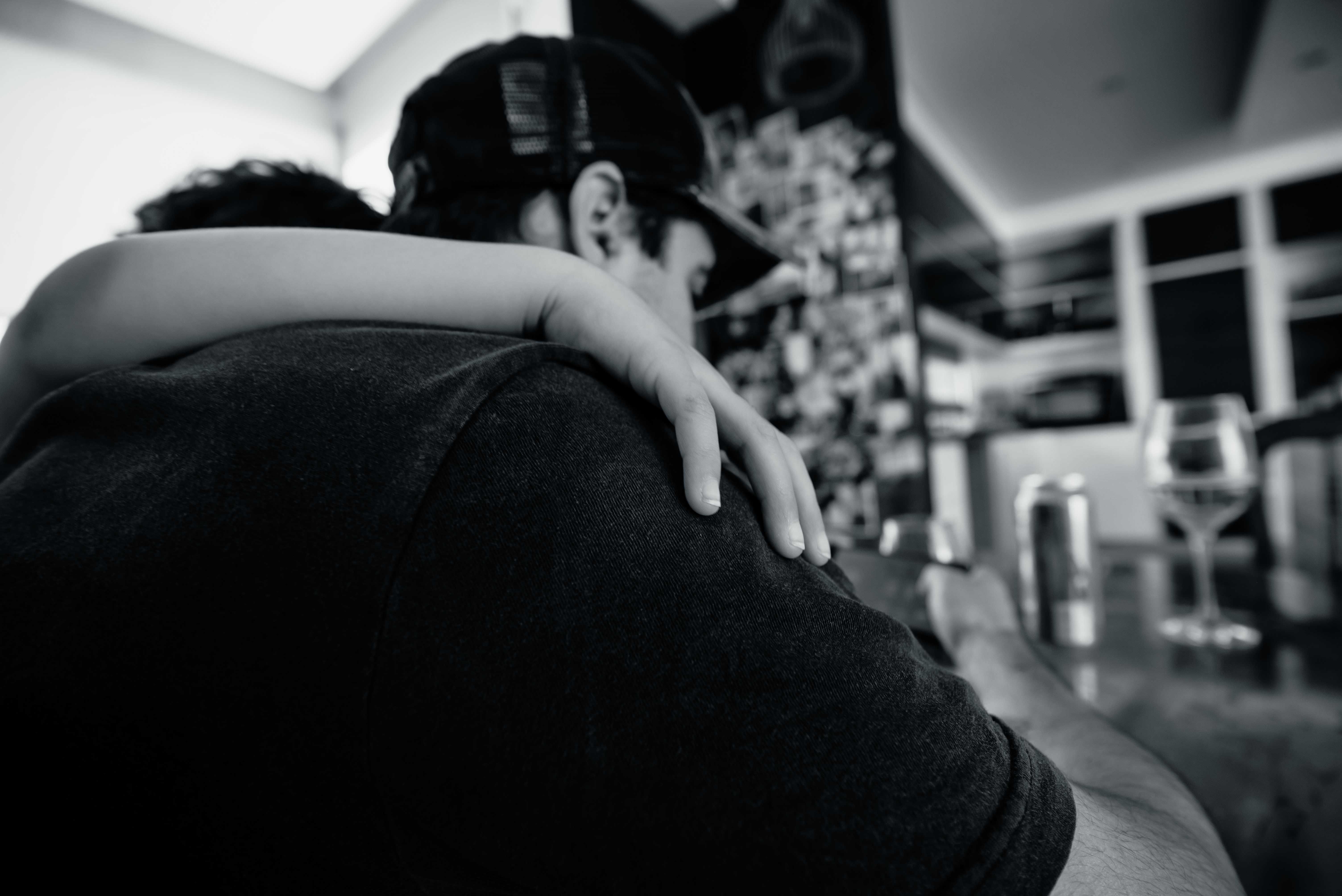 Black and White Emotional Embrace in Cafe · Free Stock Photo