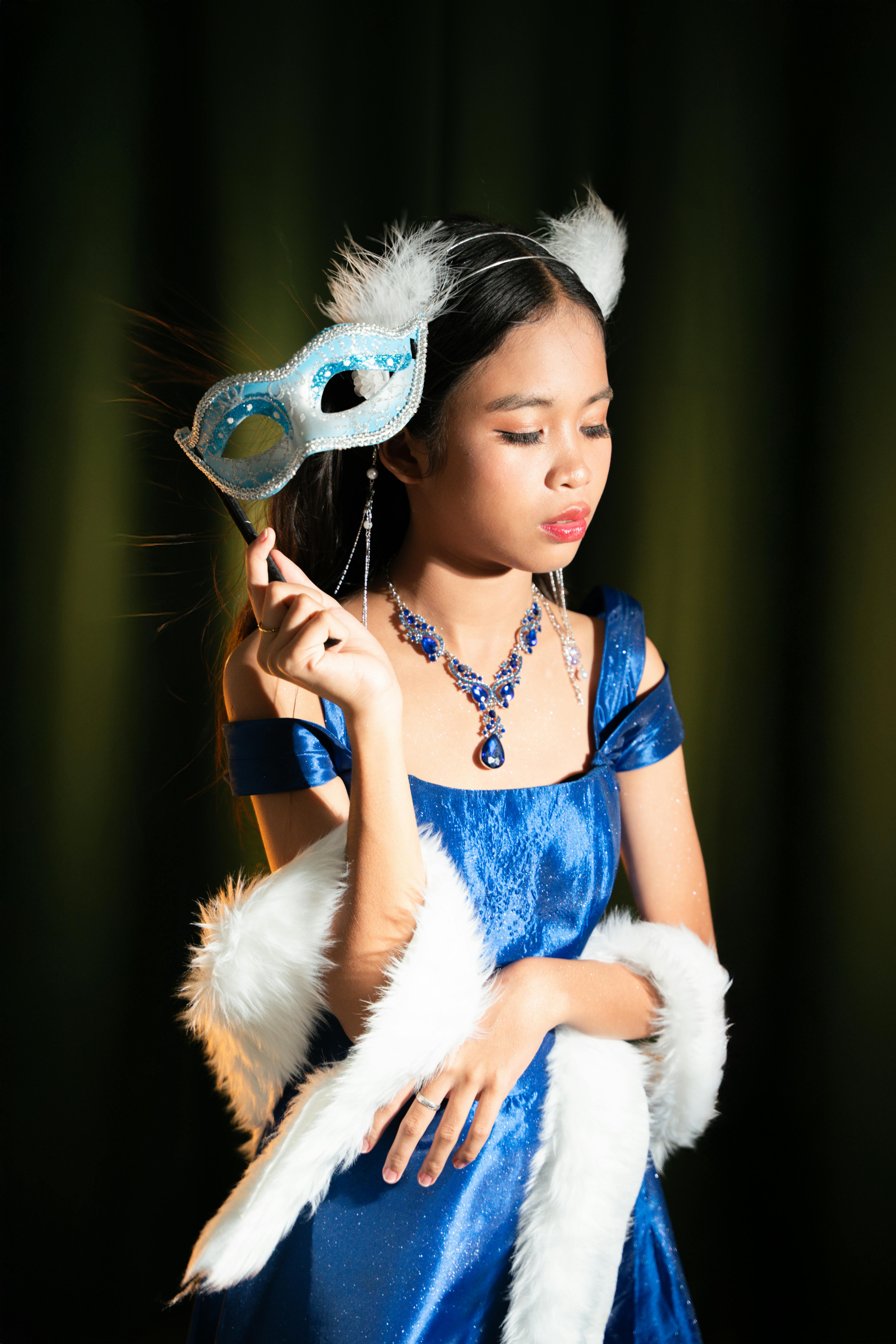 Elegant Young Woman in Blue Formal Dress with Mask · Free Stock Photo