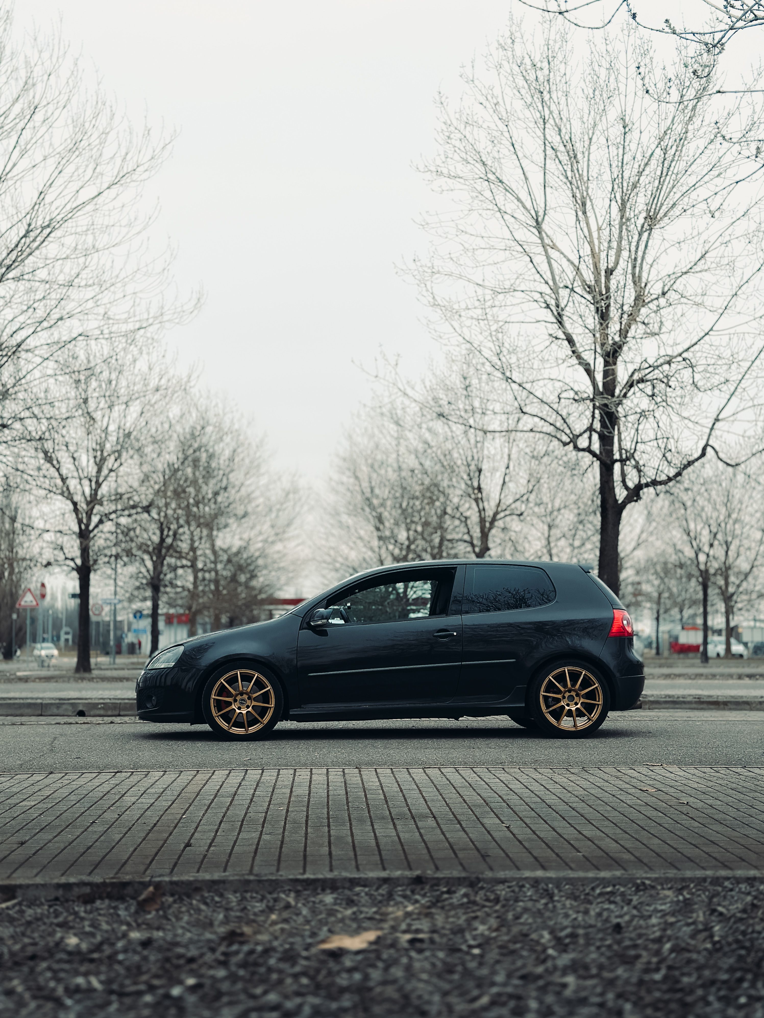 Black car on urban street in winter scene · Free Stock Photo