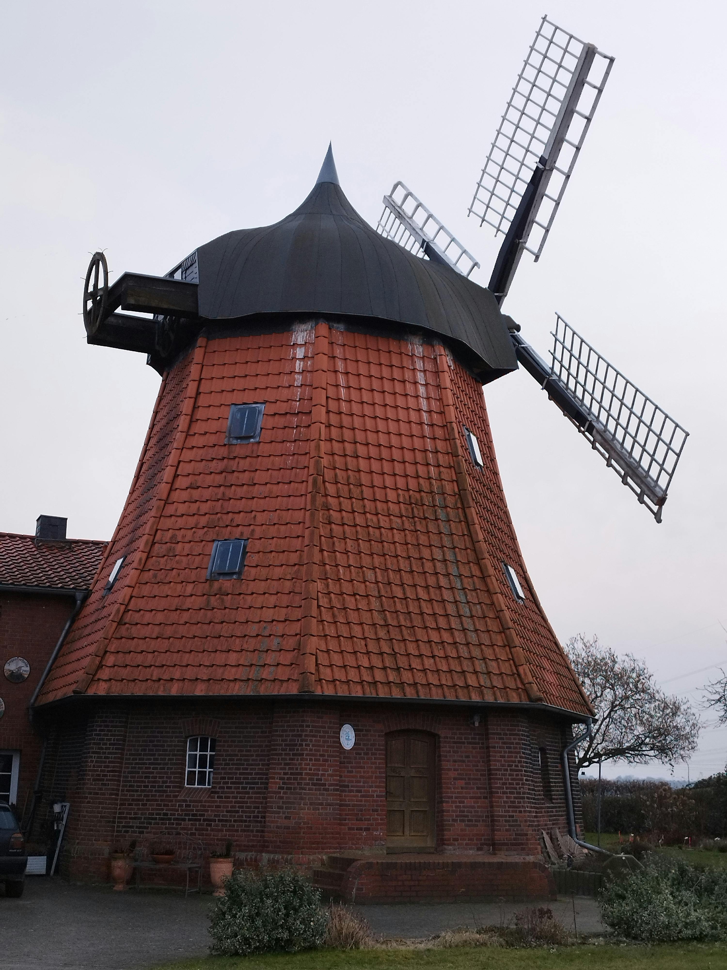Historic Brick Windmill with Red Roof and Sails · Free Stock Photo