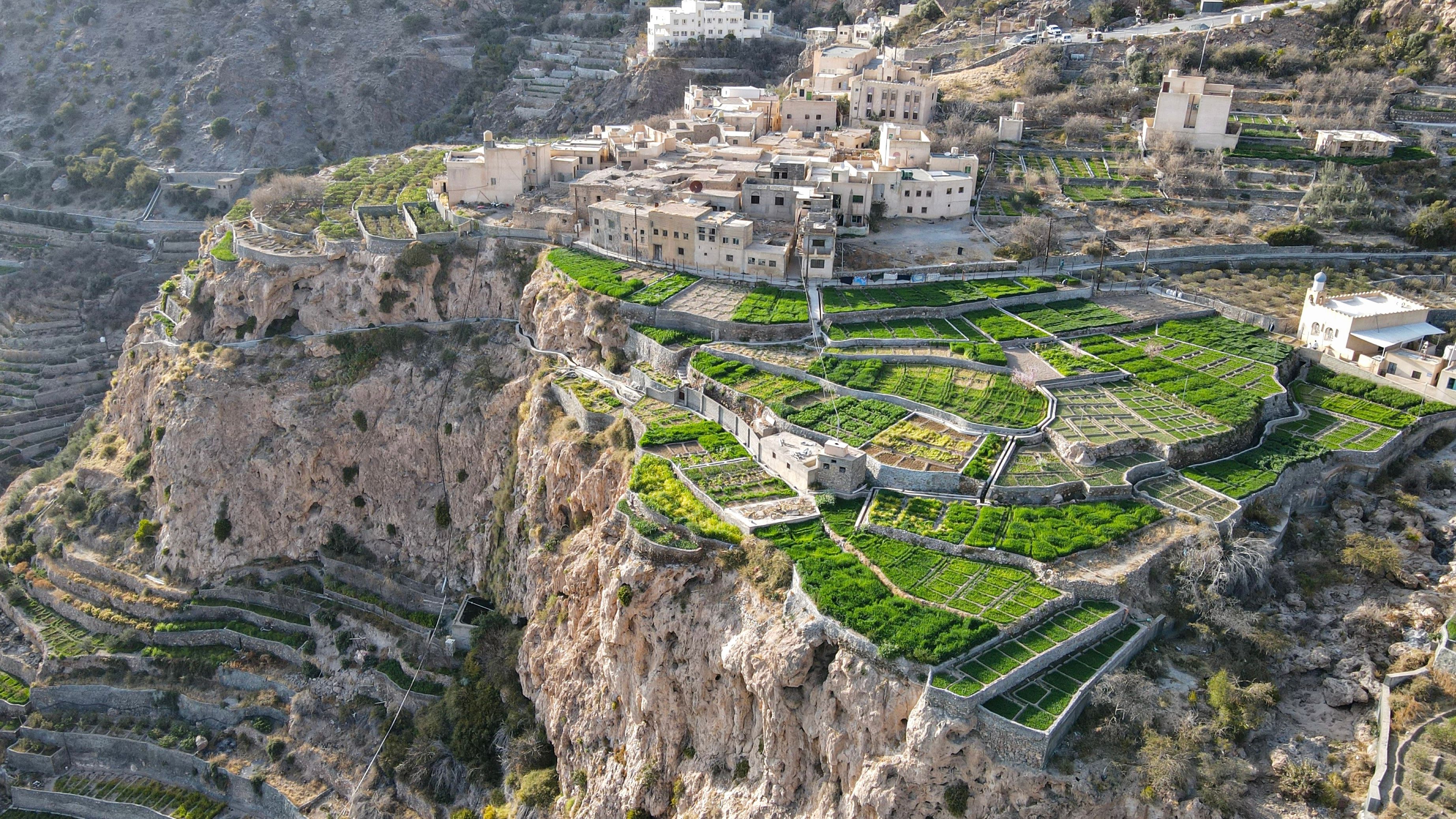 Aerial View of Terraced Fields and Village on Hill · Free Stock Photo