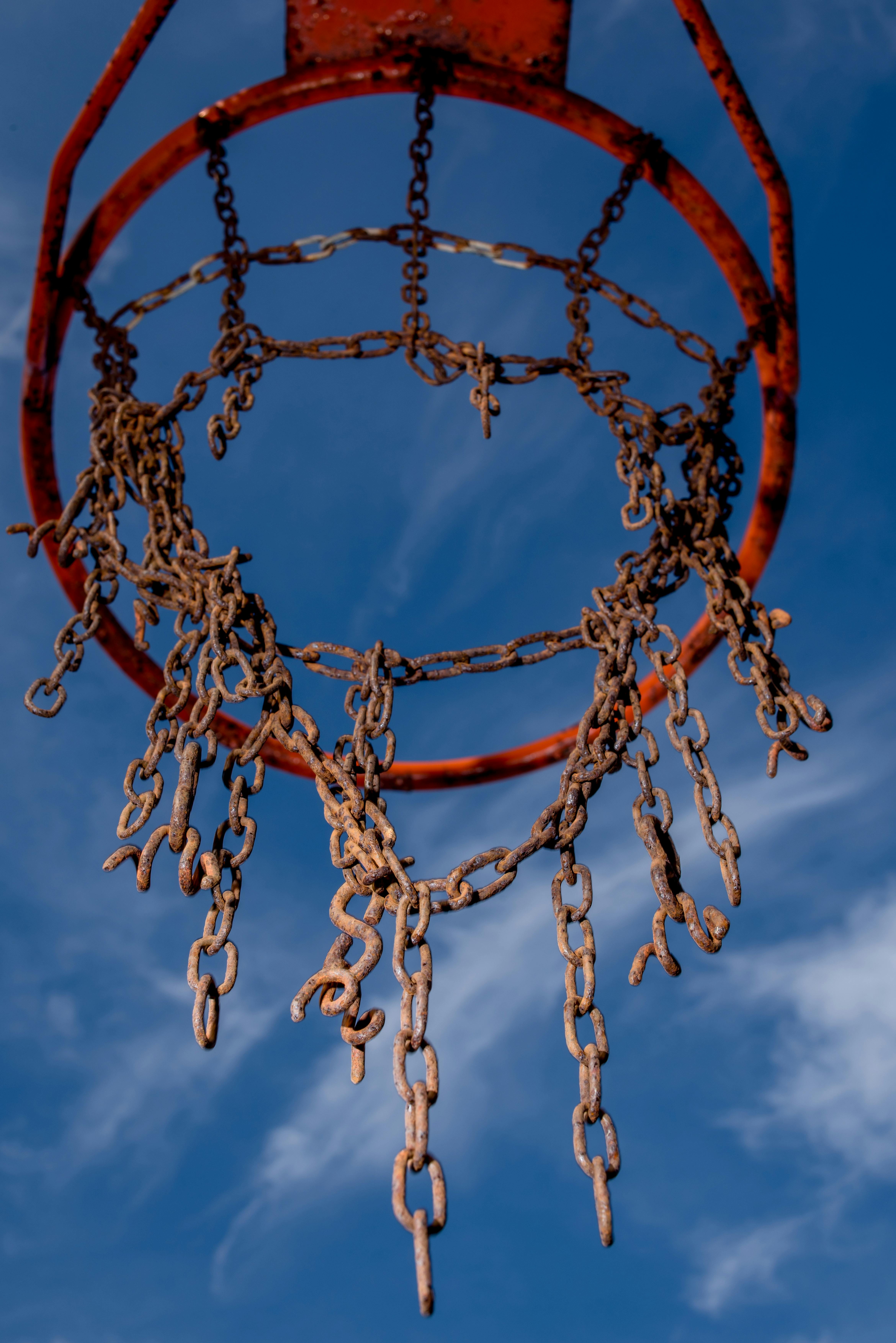 Rusty Basketball Hoop Against Clear Blue Sky · Free Stock Photo