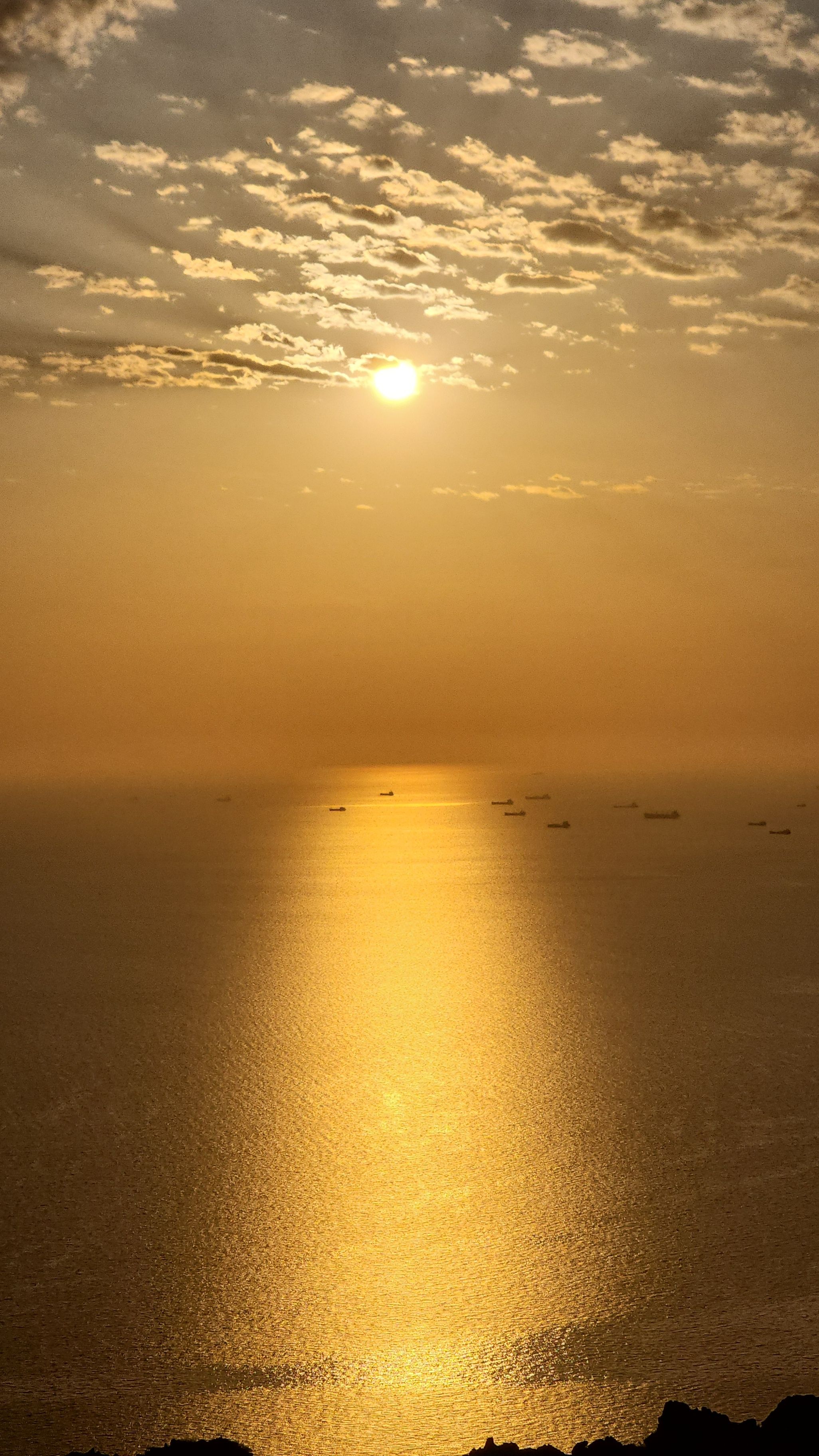 Golden Sunset Over Calm Ocean with Boats · Free Stock Photo
