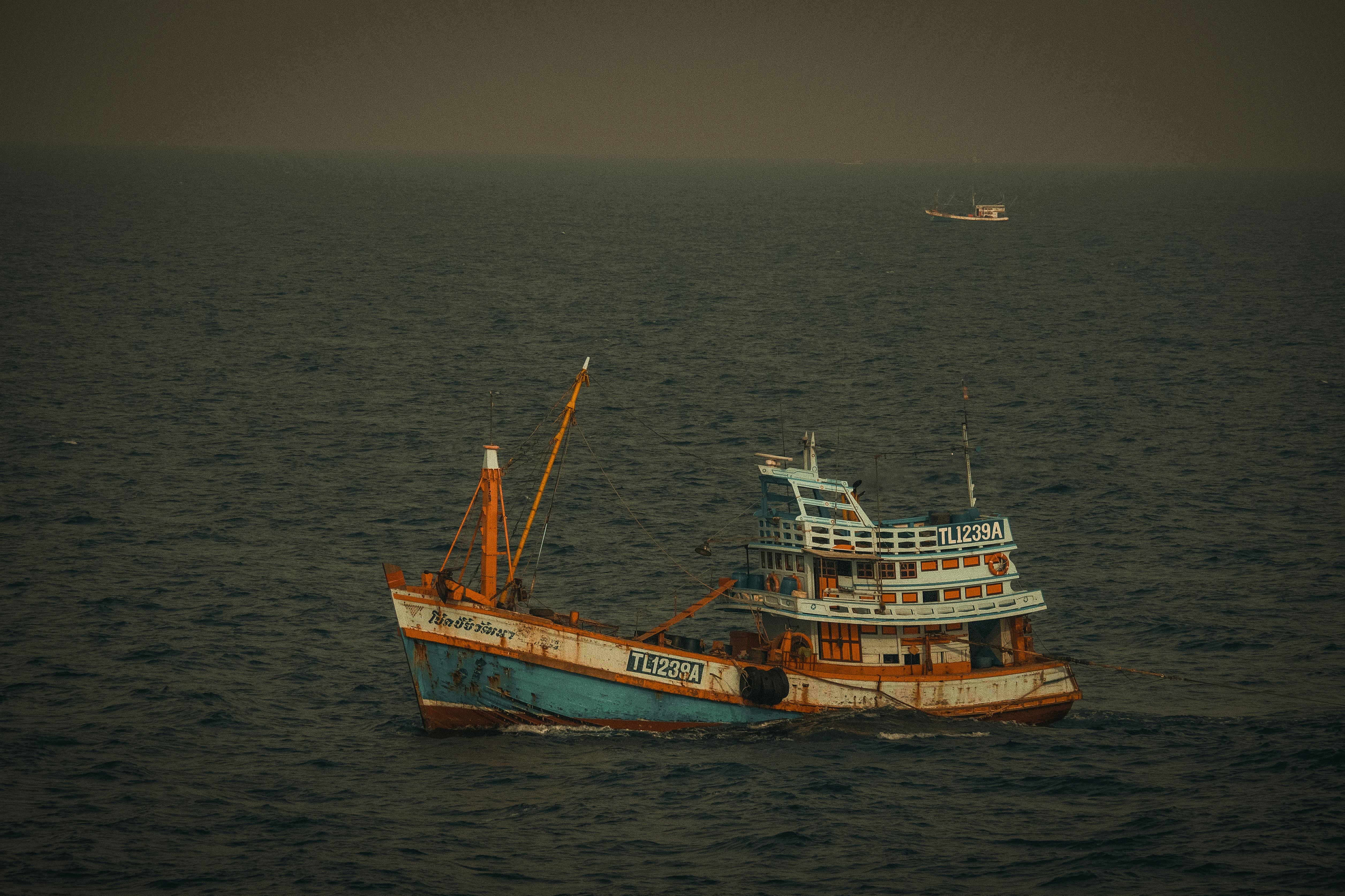 Rustic Fishing Boat on Open Sea at Dusk · Free Stock Photo