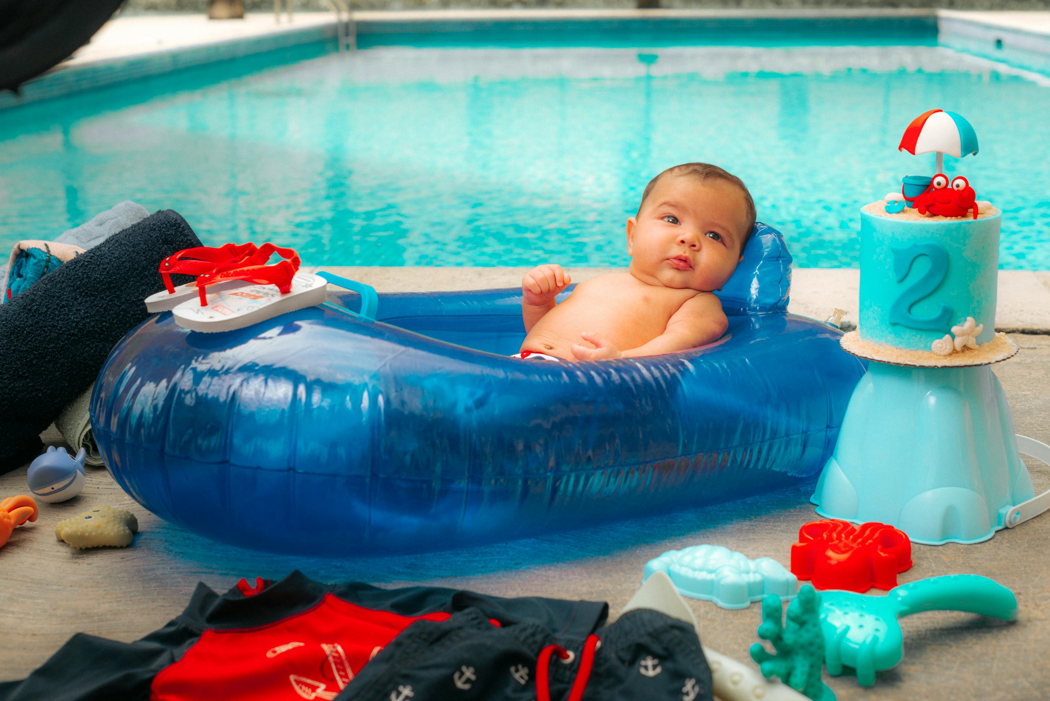 Adorable Baby in Pool with Blue Birthday Decor · Free Stock Photo